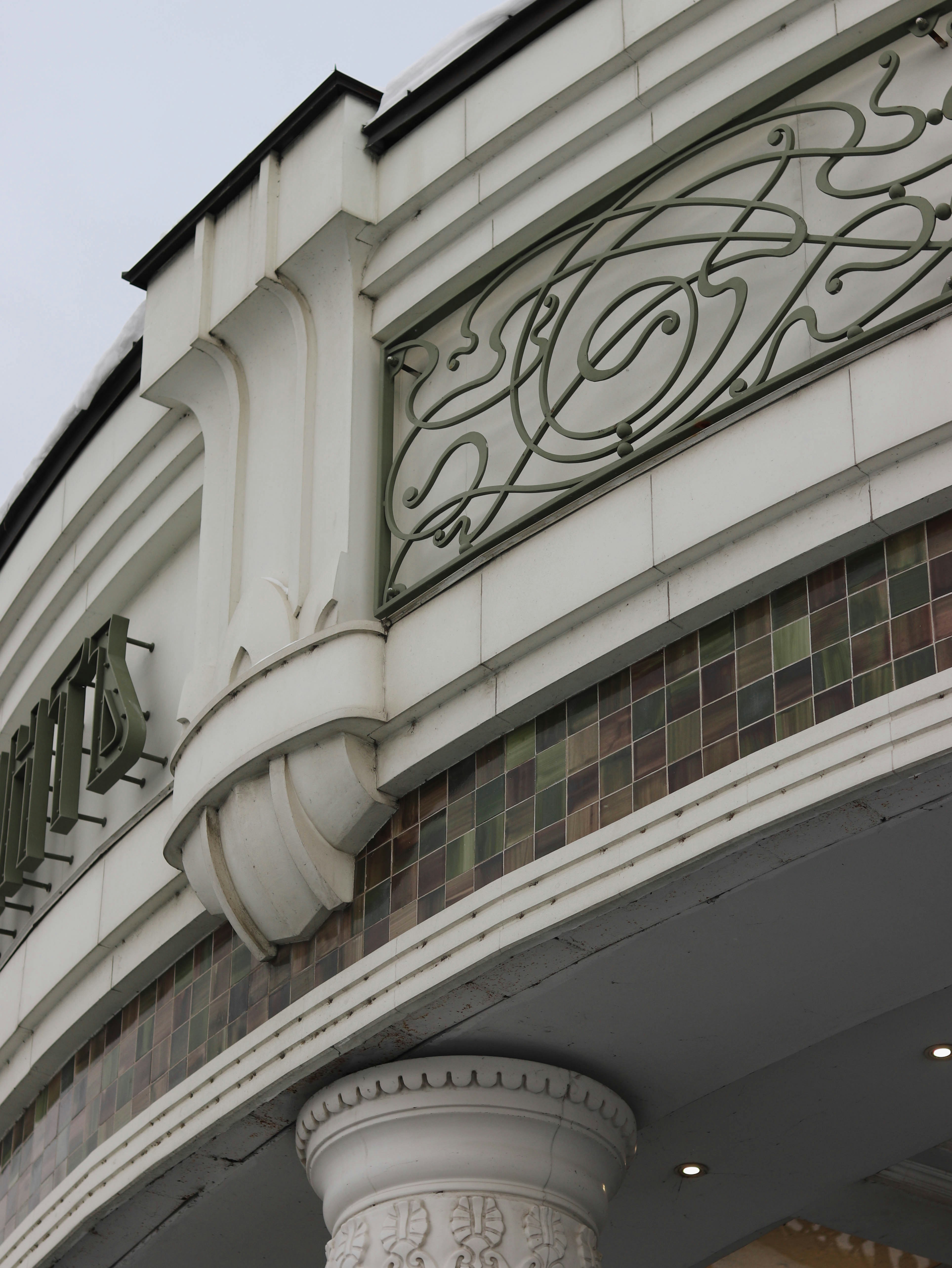 Ornate Facade Details: Curved Architectural Elements and Mosaic Trim