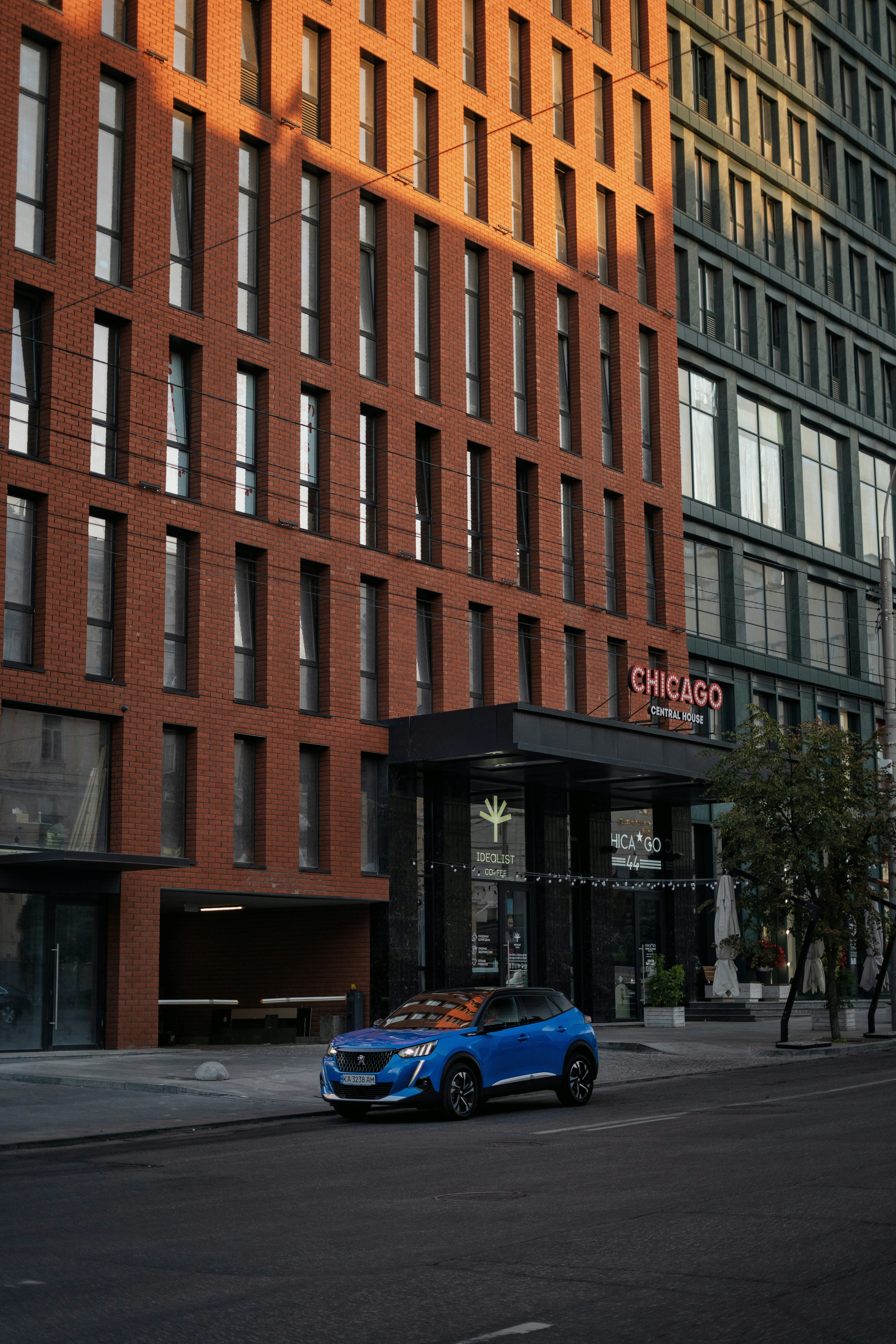 Blue crossover against a brick Chicago façade at golden-hour light