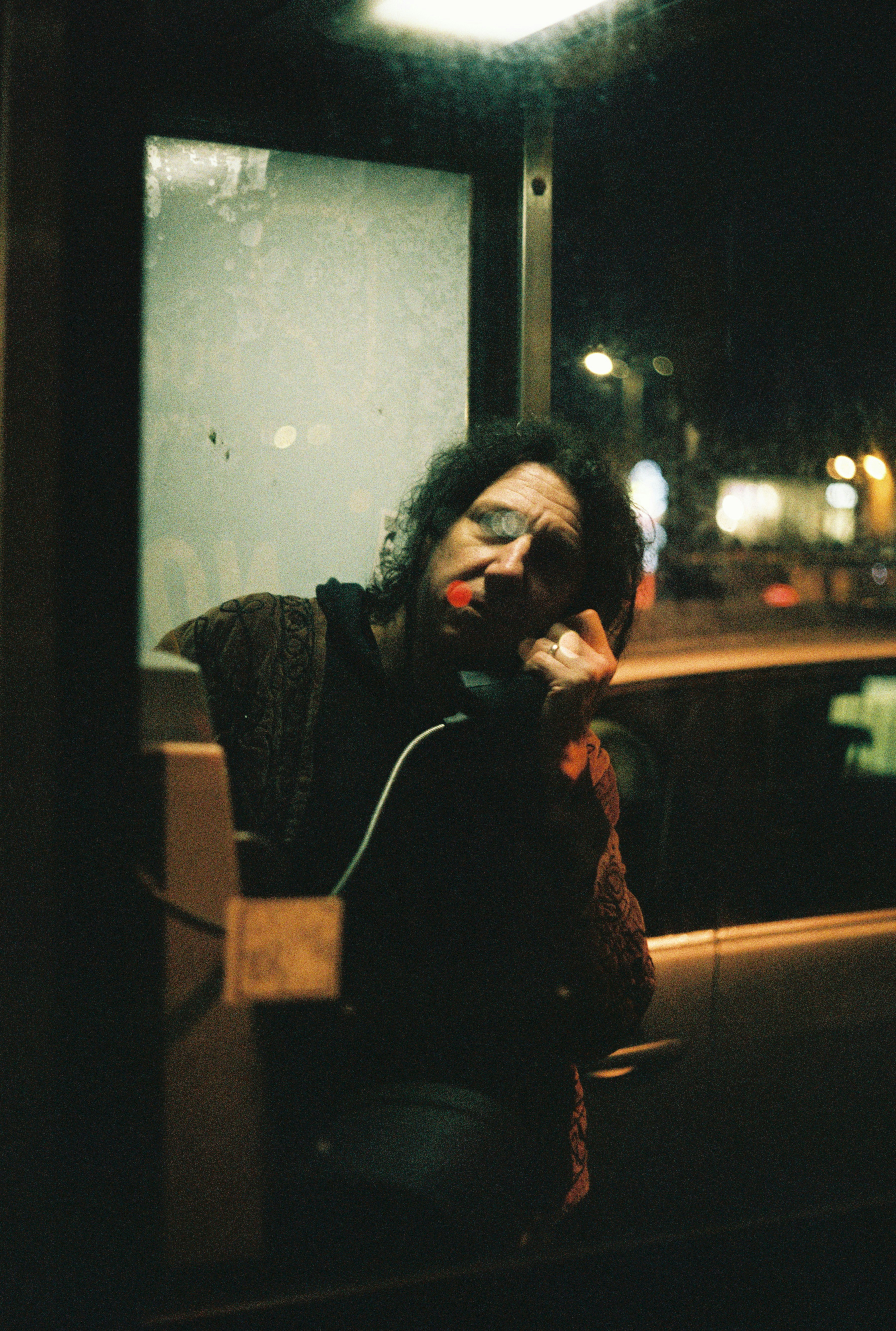 Night Busker: A Shaded Self-Portrait Reflected in Glass