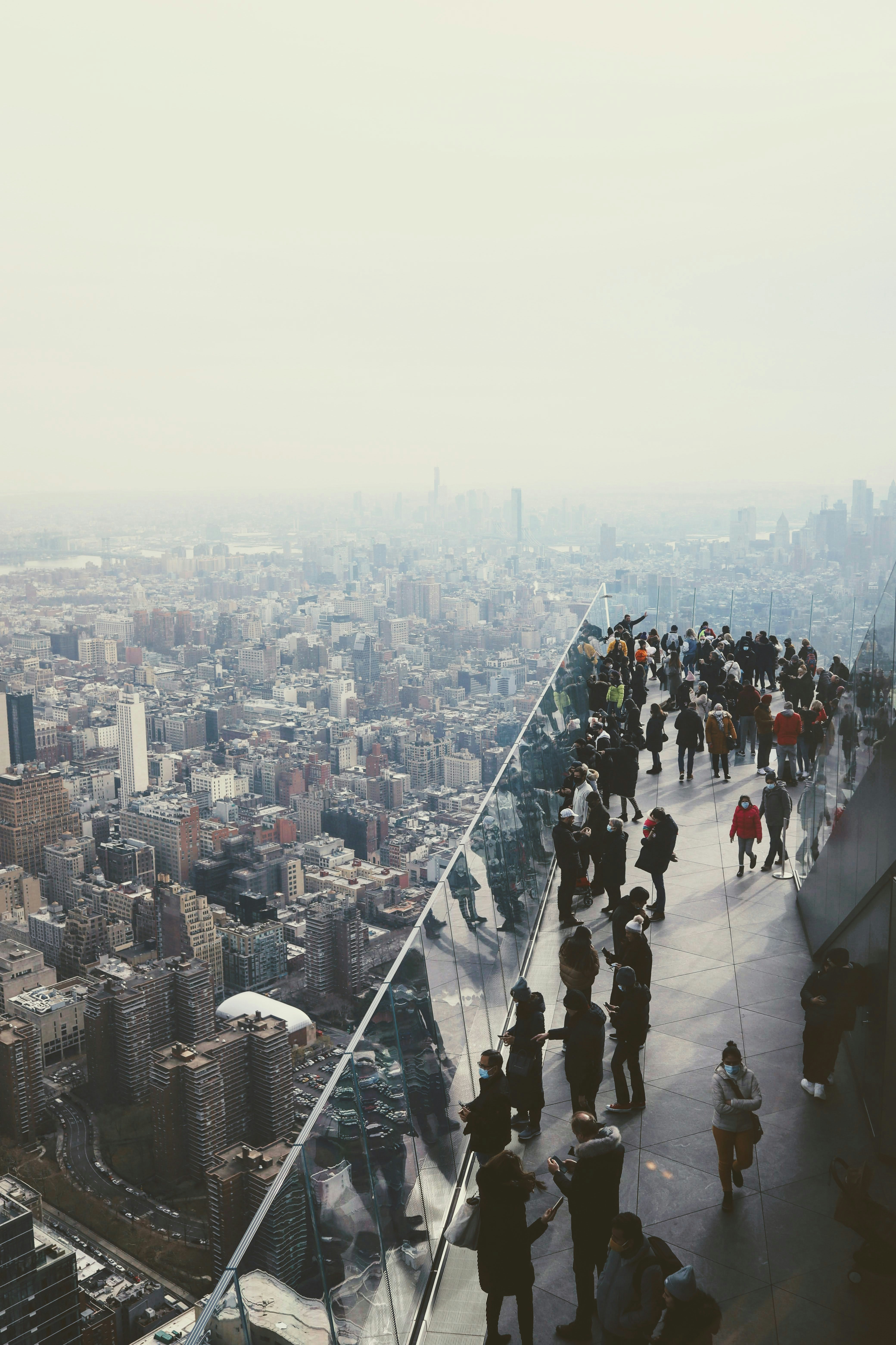 A group of people standing on top of a tall building photo – Free New ...
