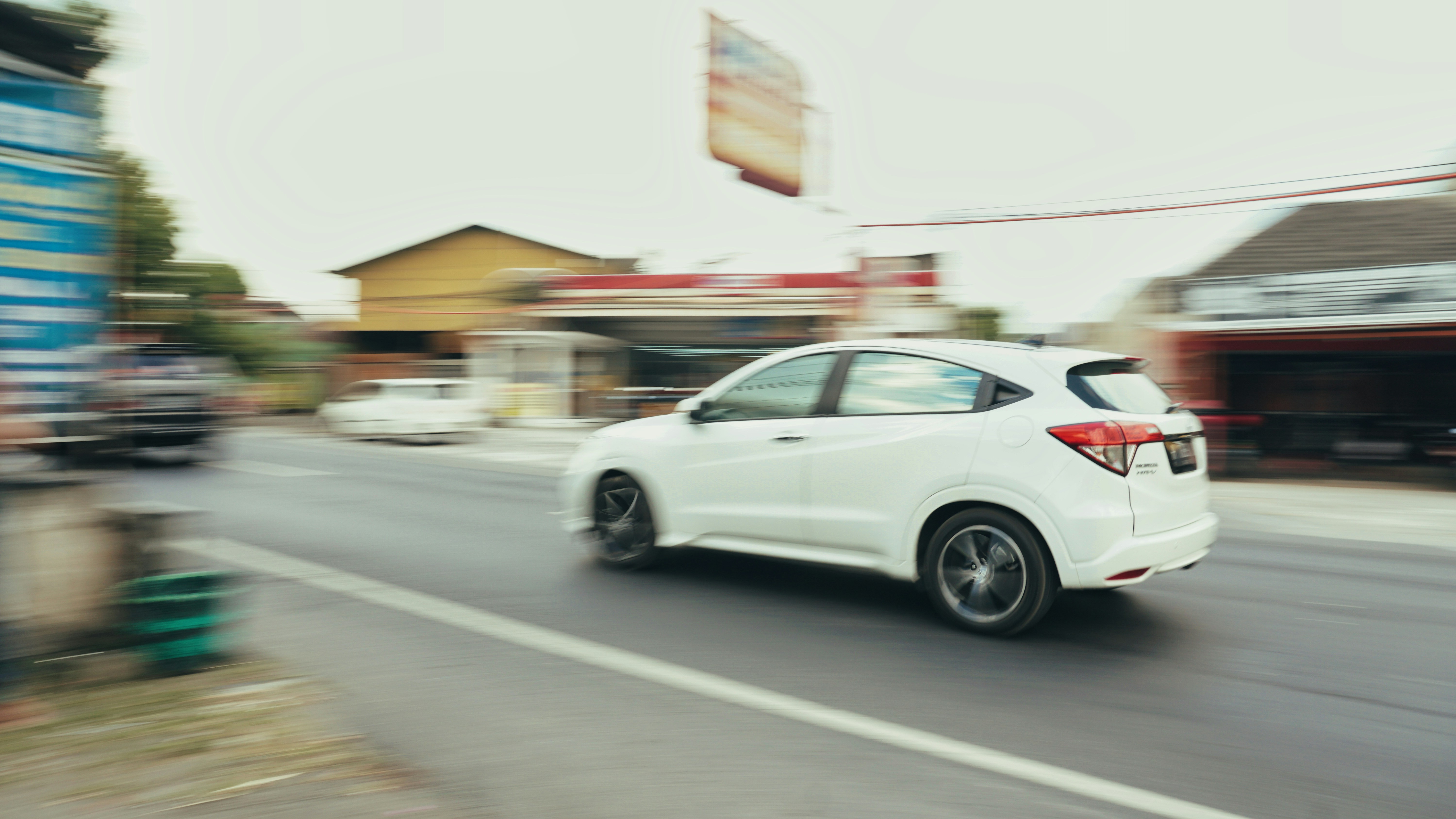 Time-Lapse in Motion: White SUV on a Blur-Washed Street