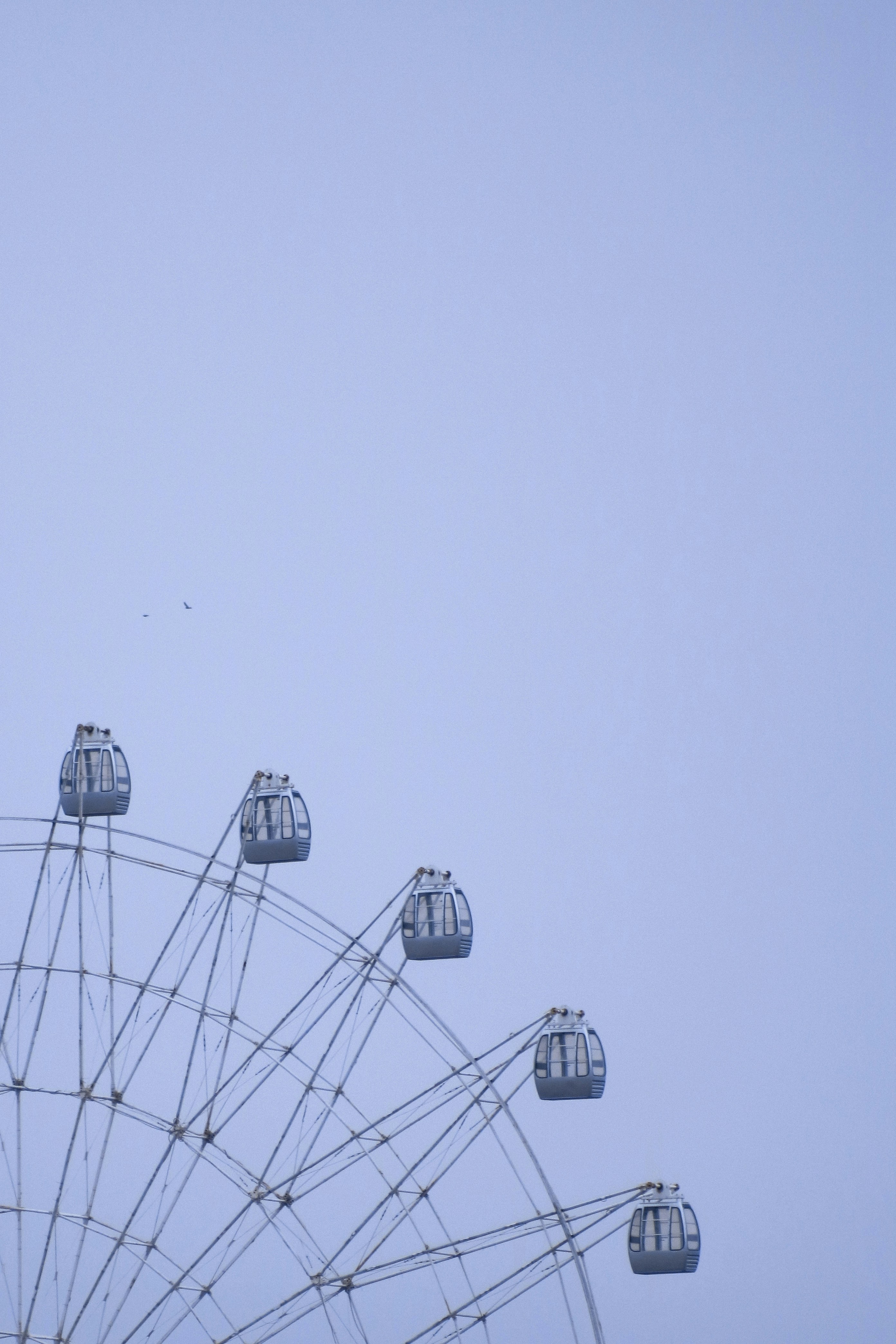 a ferris wheel in the middle of a cloudy sky