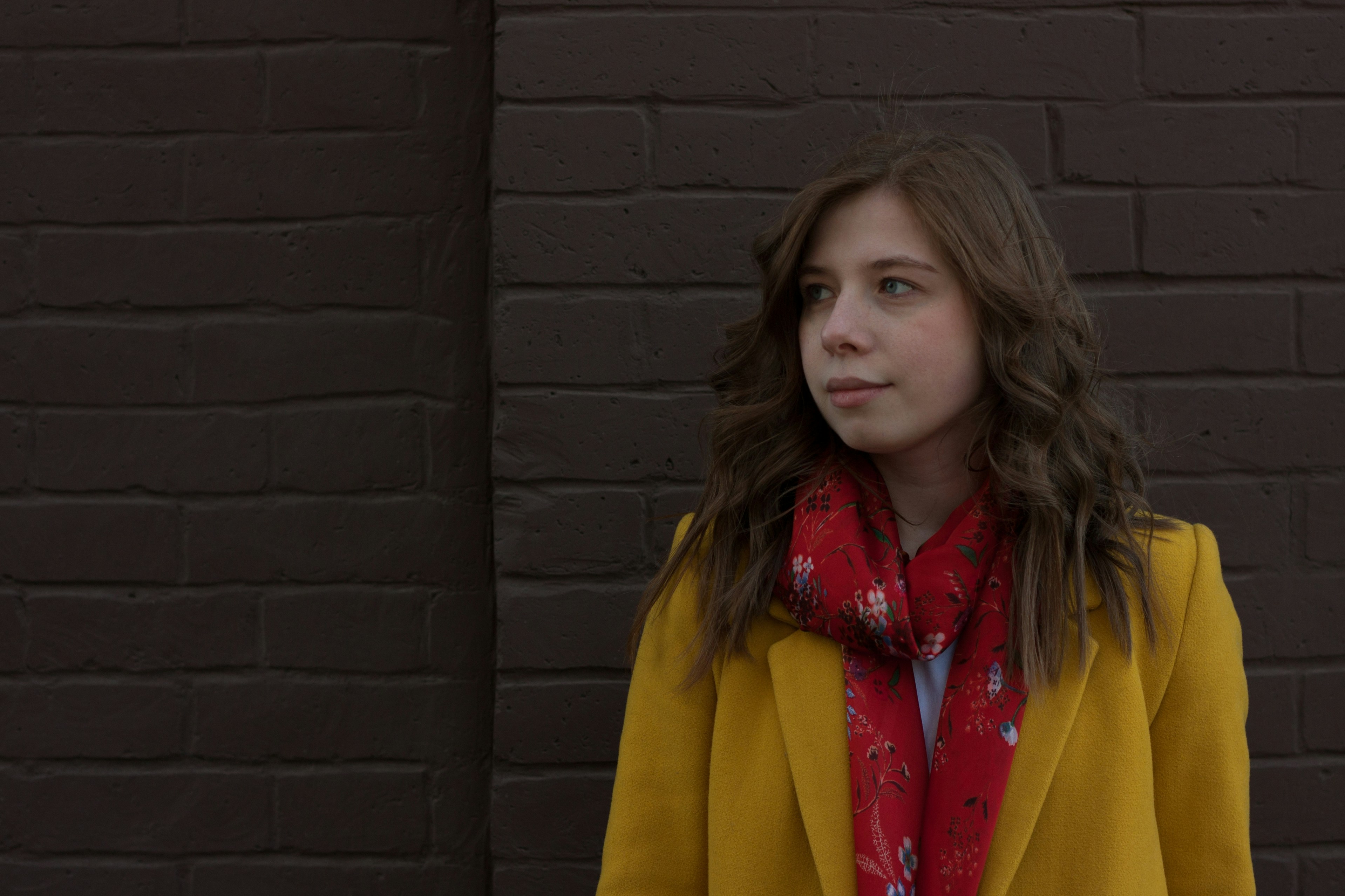 A young girl wearing a yellow coat and a red scarf photo – Free Arma ...