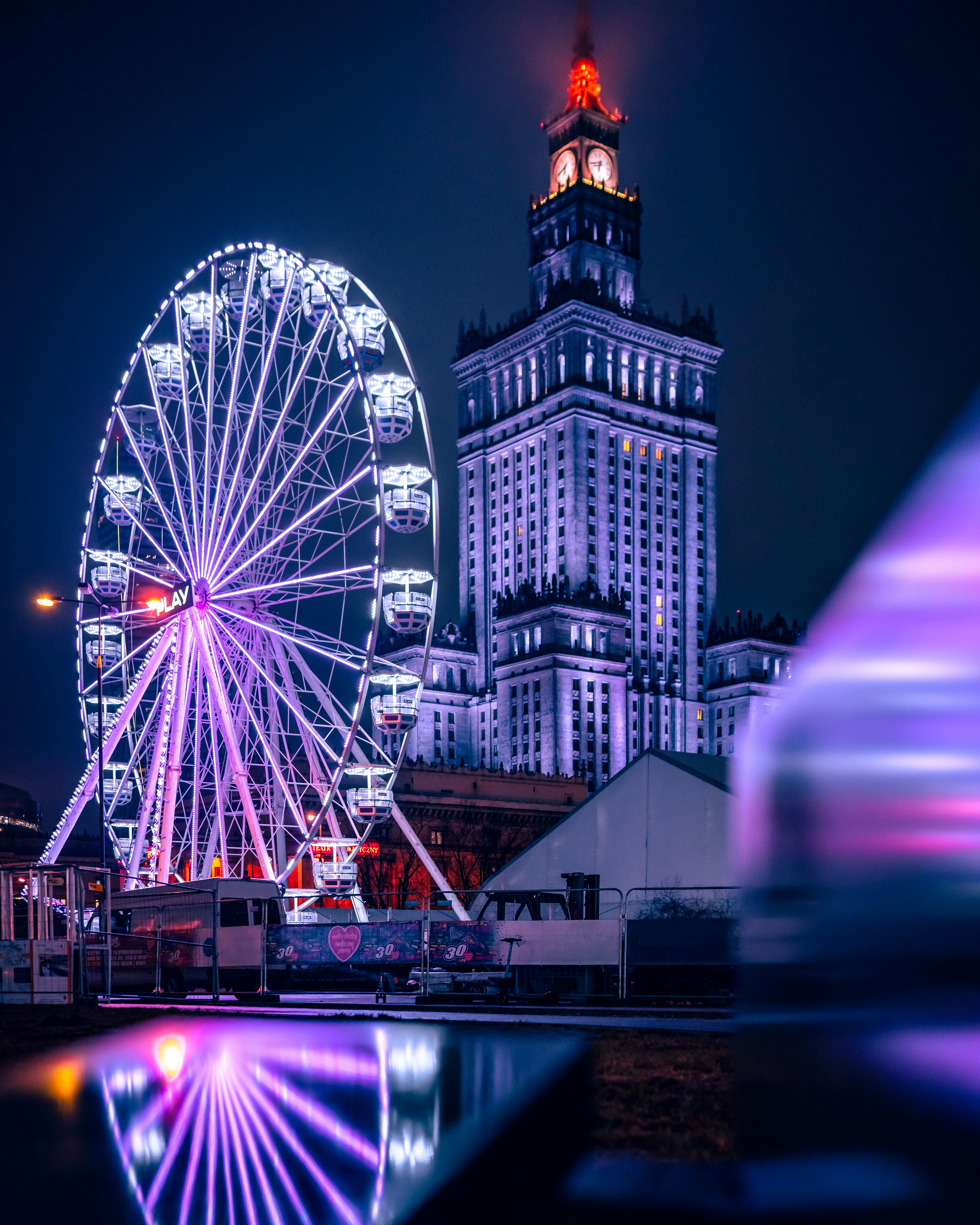 Neon Wheel and Clocktower at Night