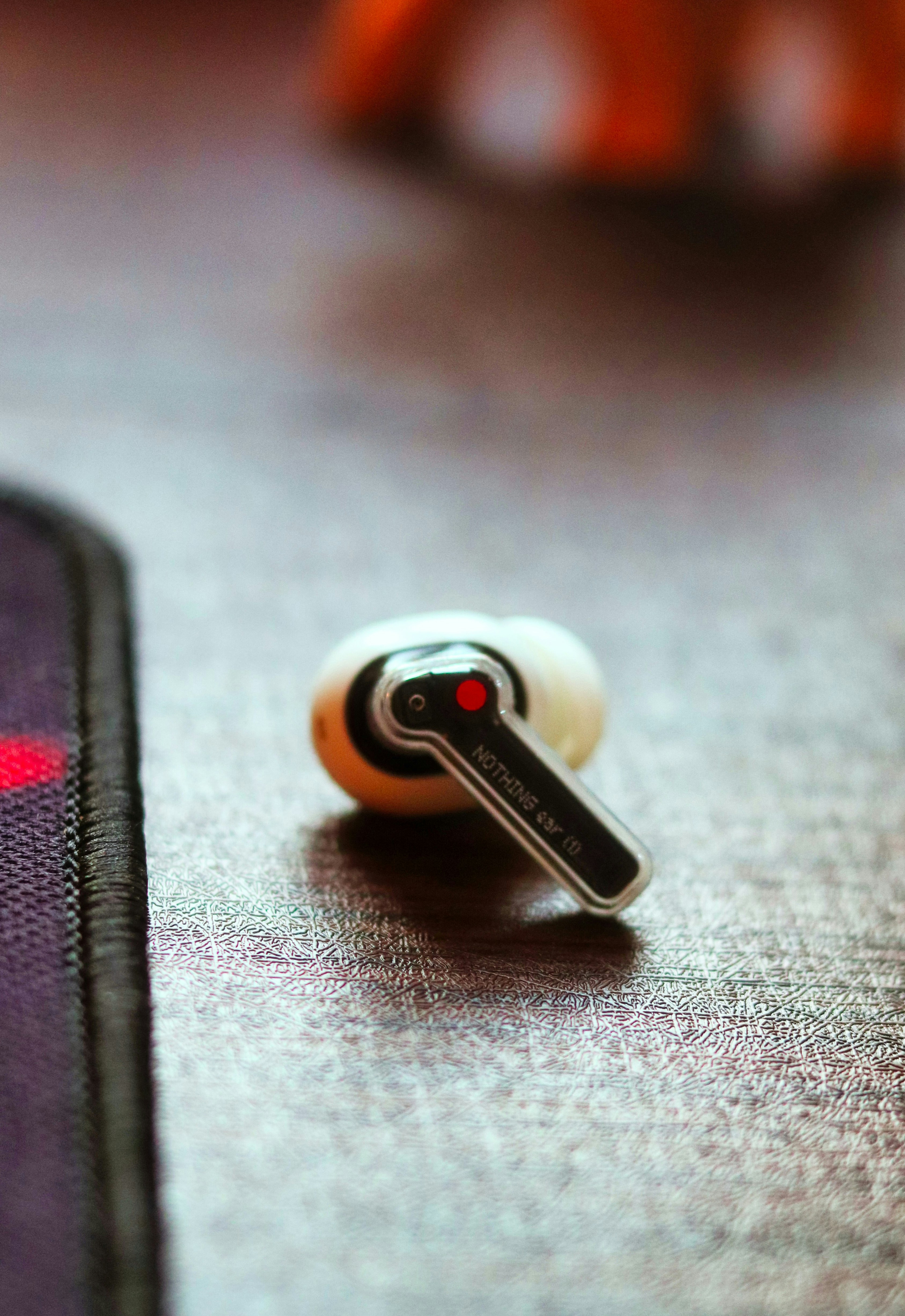 A pair of ear buds sitting on top of a table photo – Free Ios ...