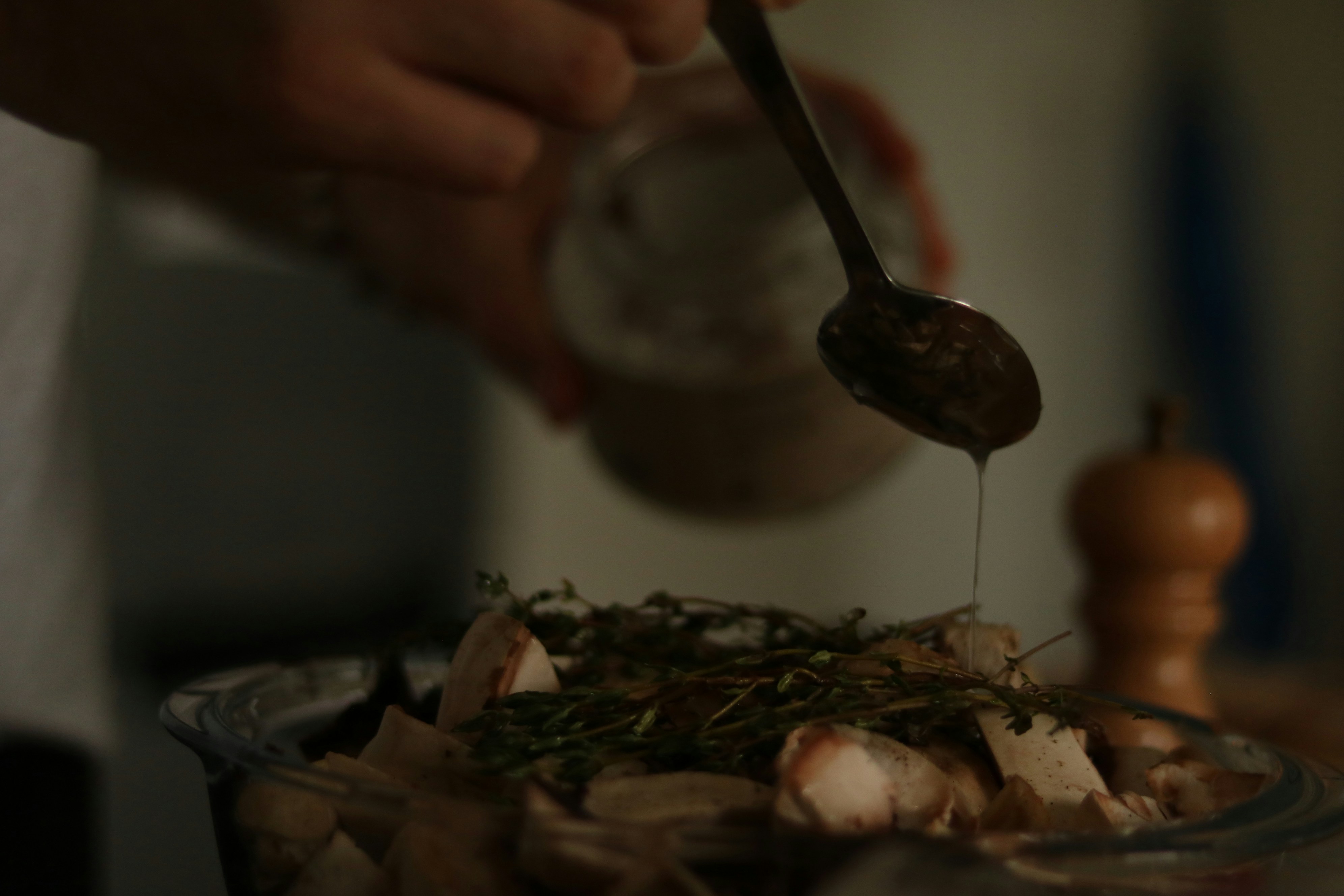 A person spooning something over a bowl of food photo – Free ...
