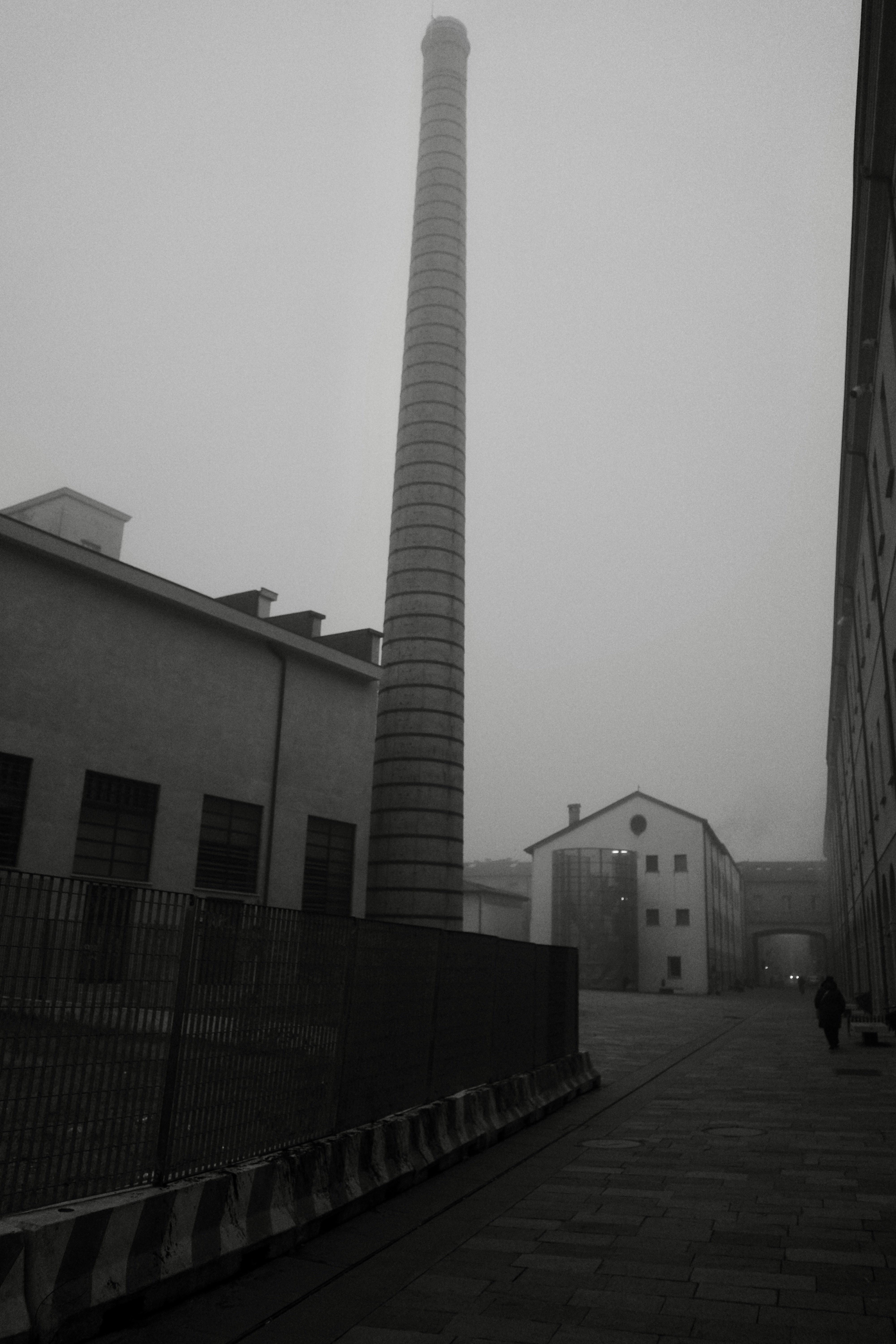 a black and white photo of a smoke stack