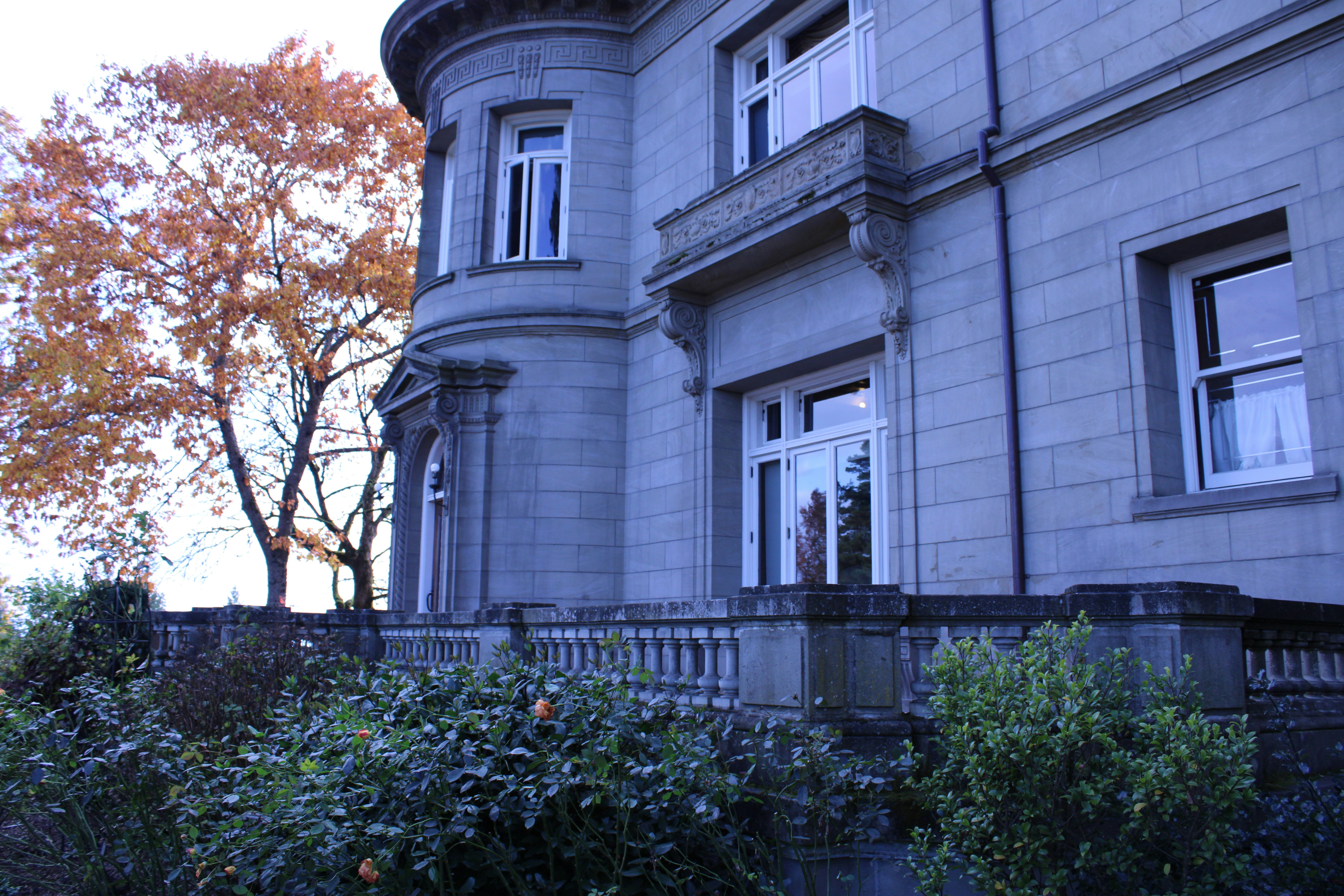 a large gray building with a clock on the front of it