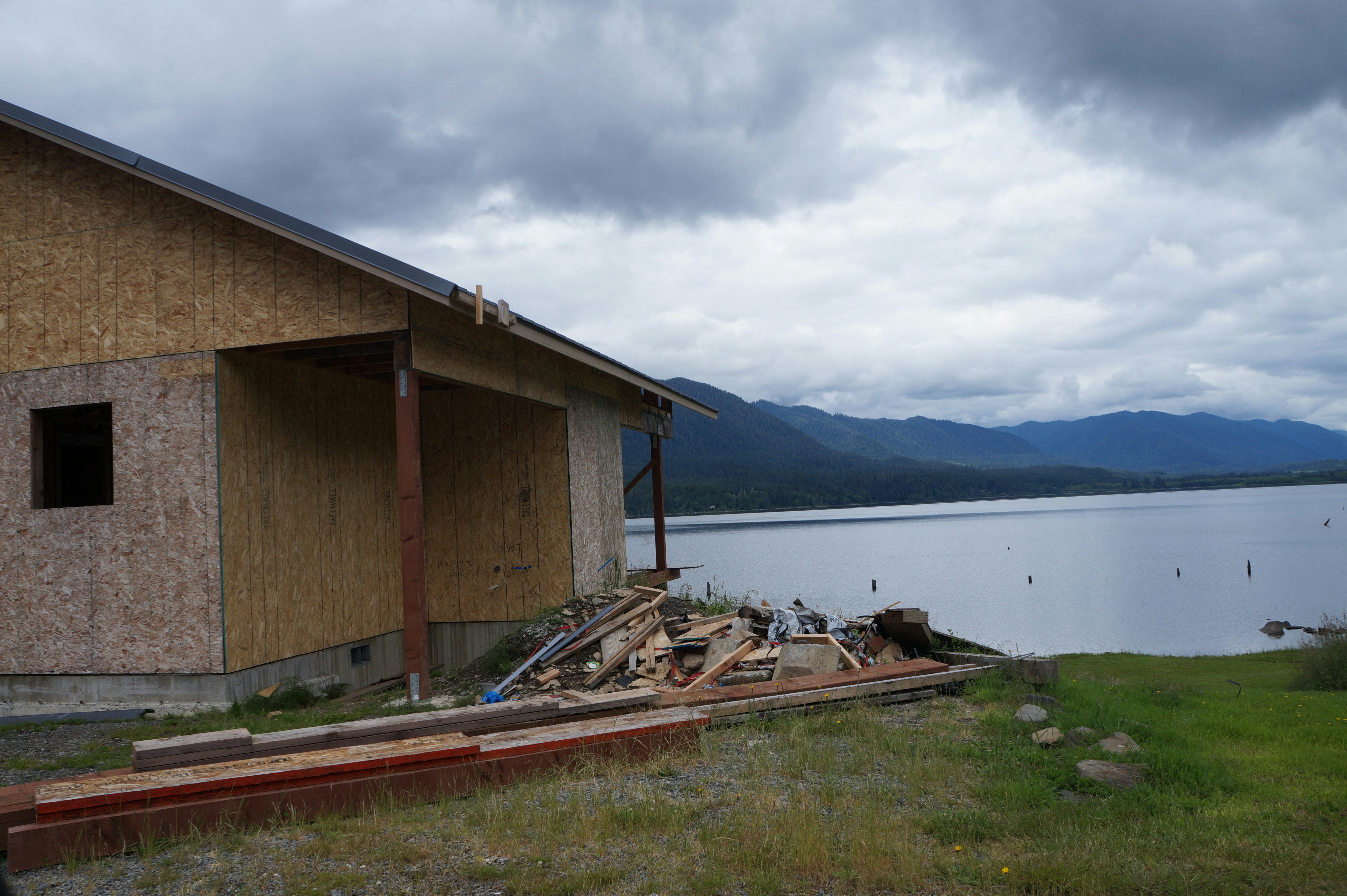 a house that is under construction next to a body of water