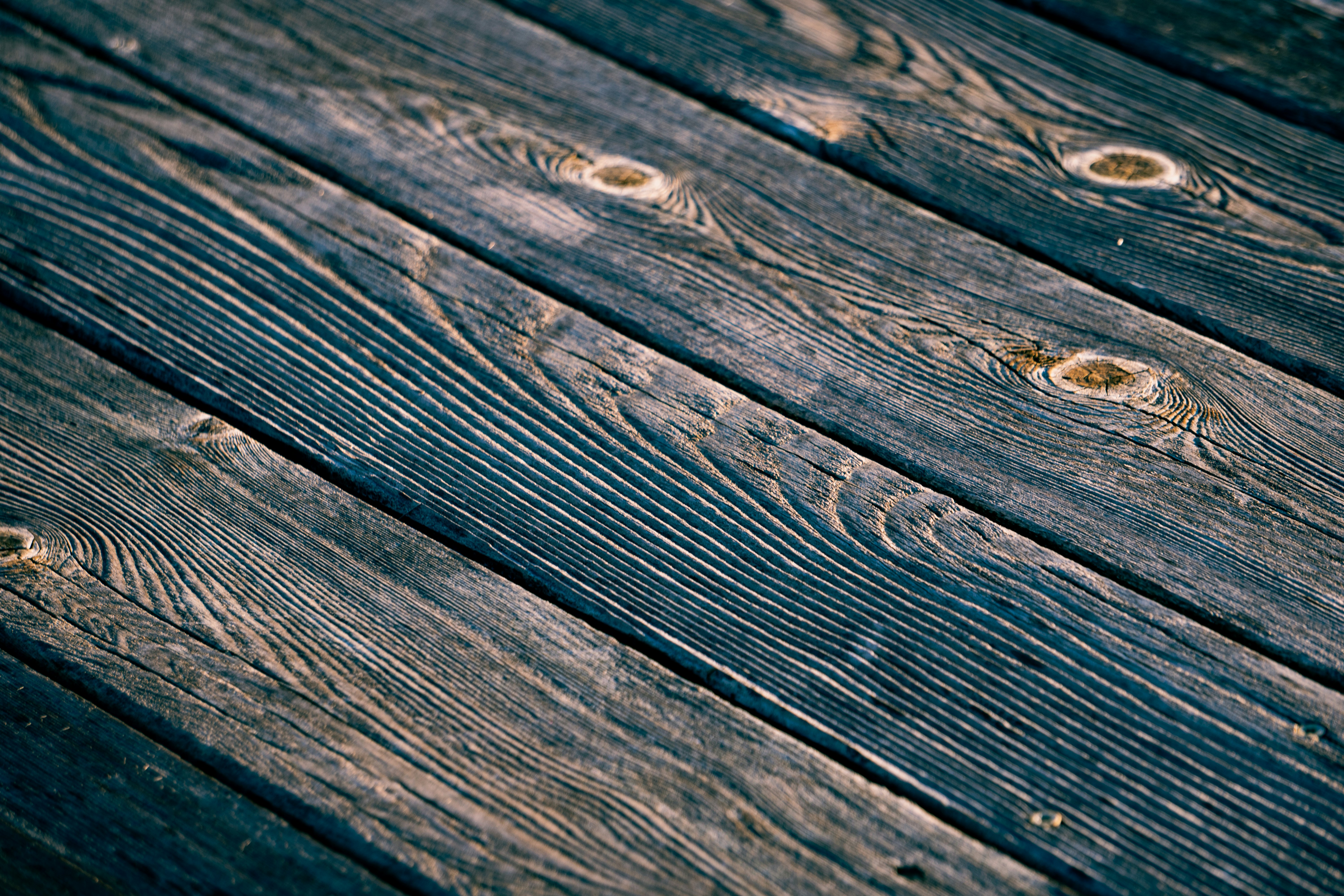Close-up of weathered wooden planks showcasing intricate grain patterns and knots.