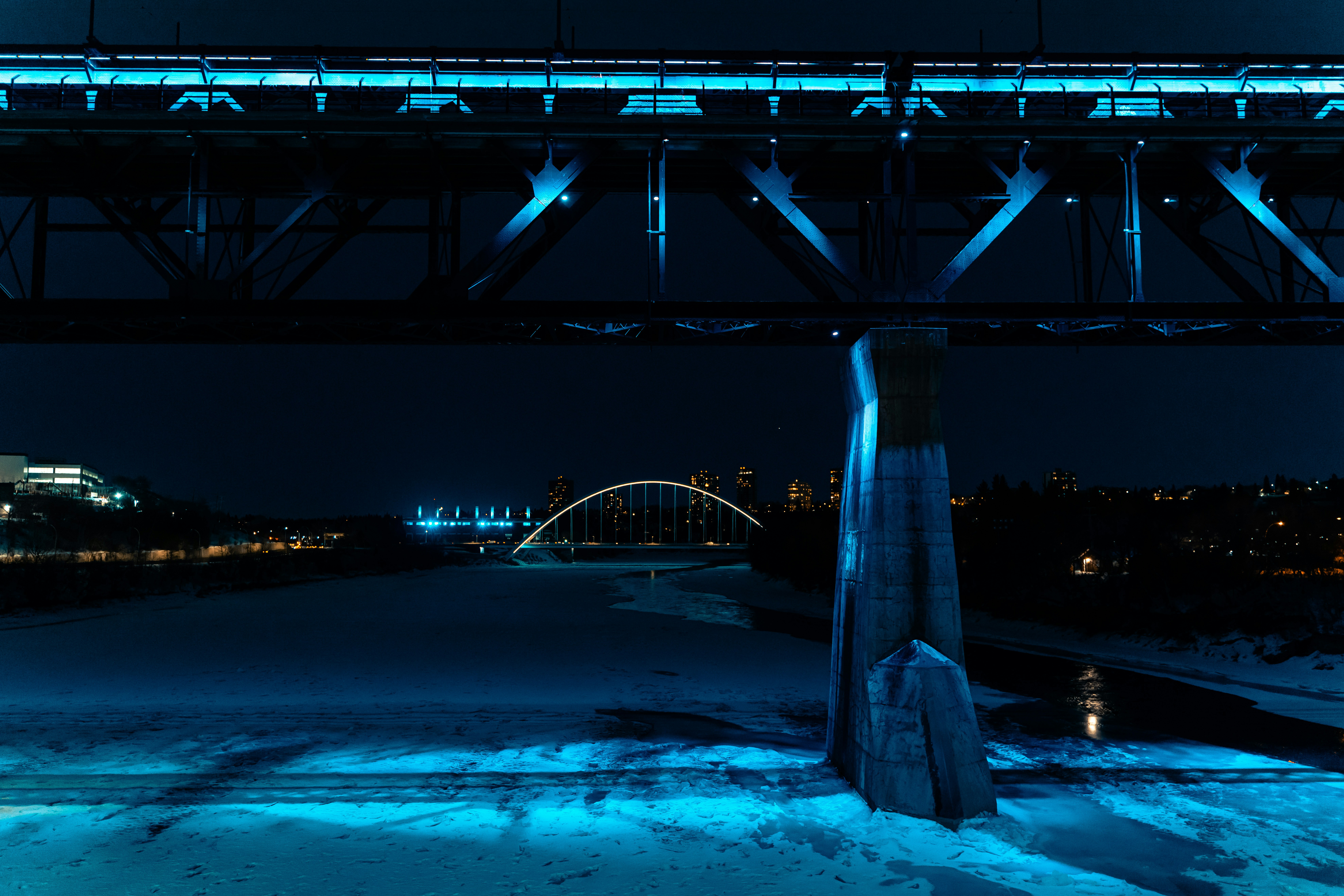 A train traveling over a bridge at night photo – Free Night Image on ...