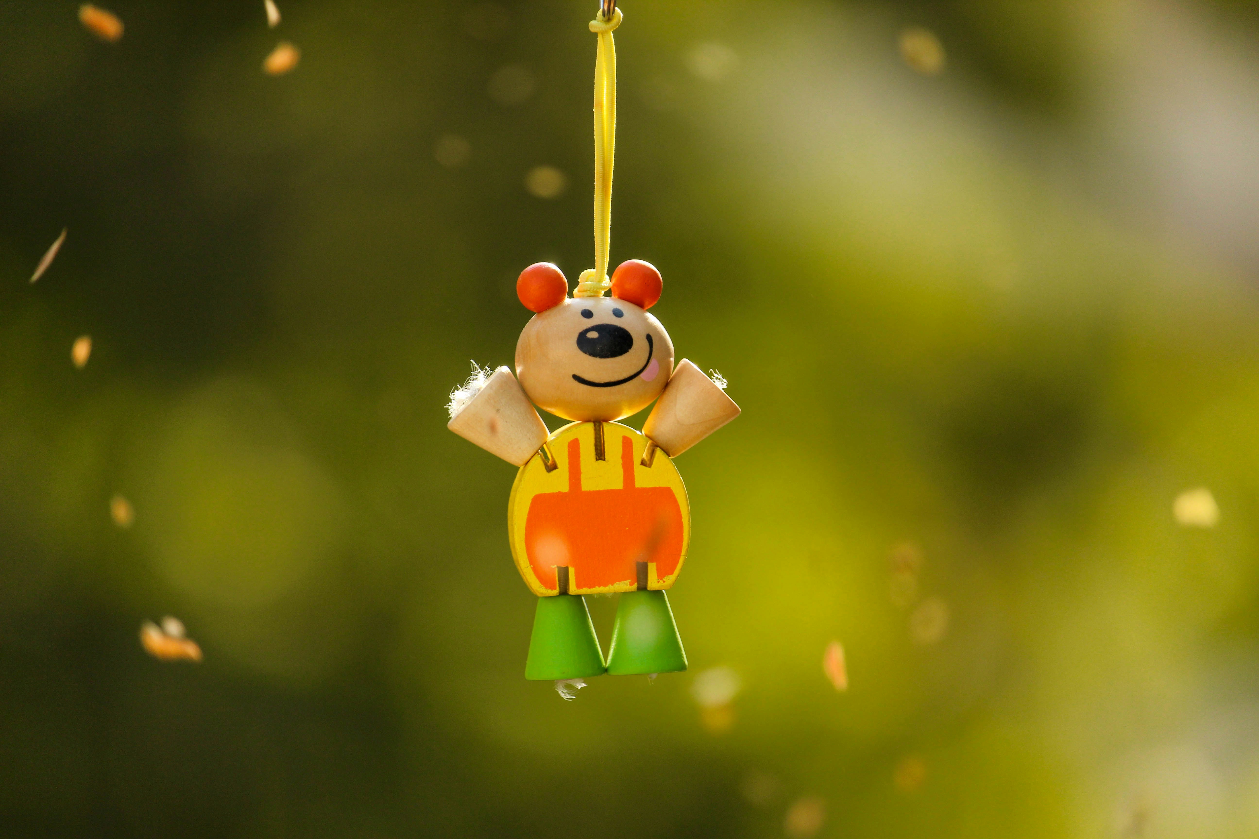 Hanging cheerful toy charm frozen in sunlight