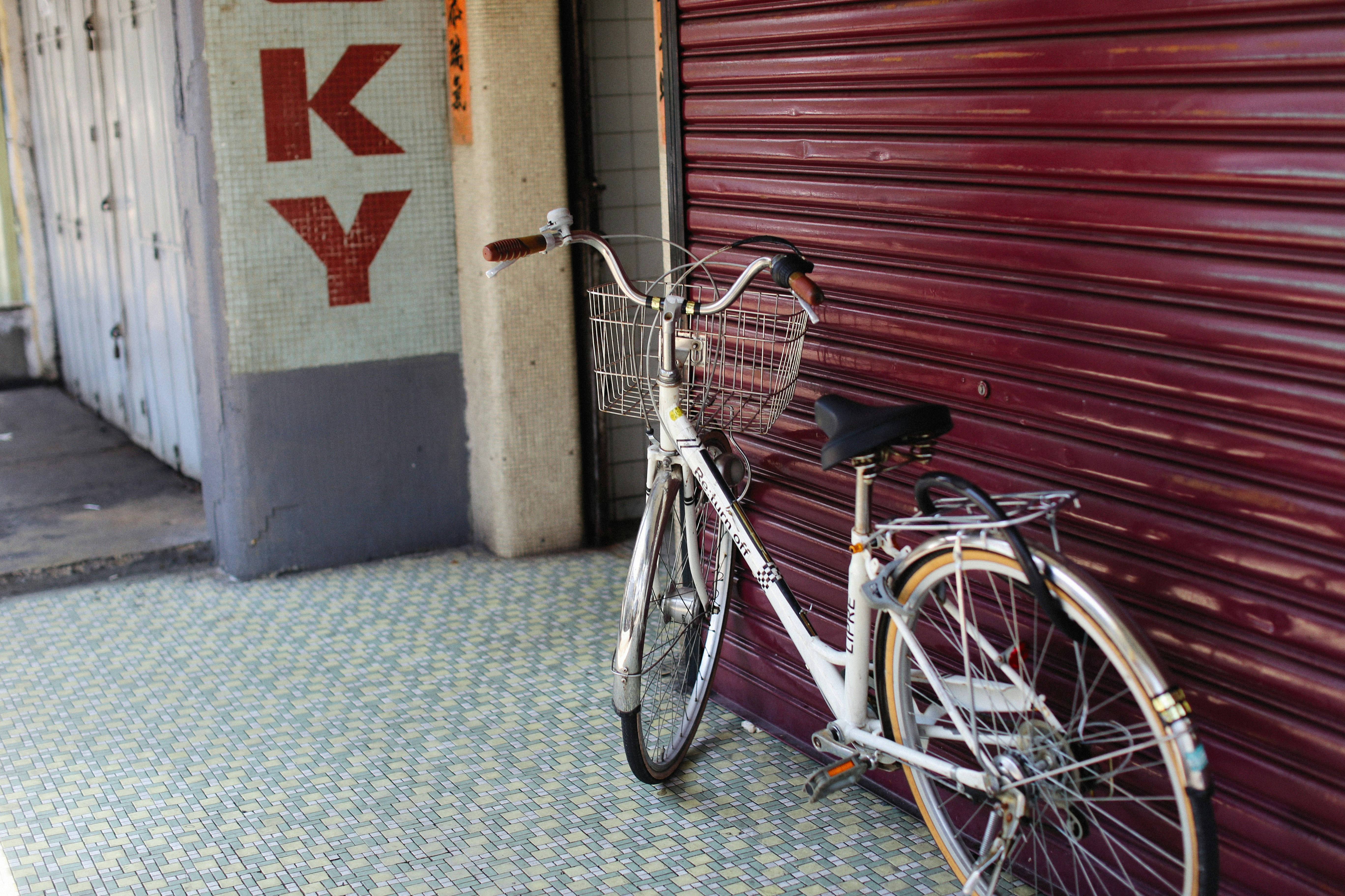 White Bicycle by the Red Shutter: Quiet Street Corner