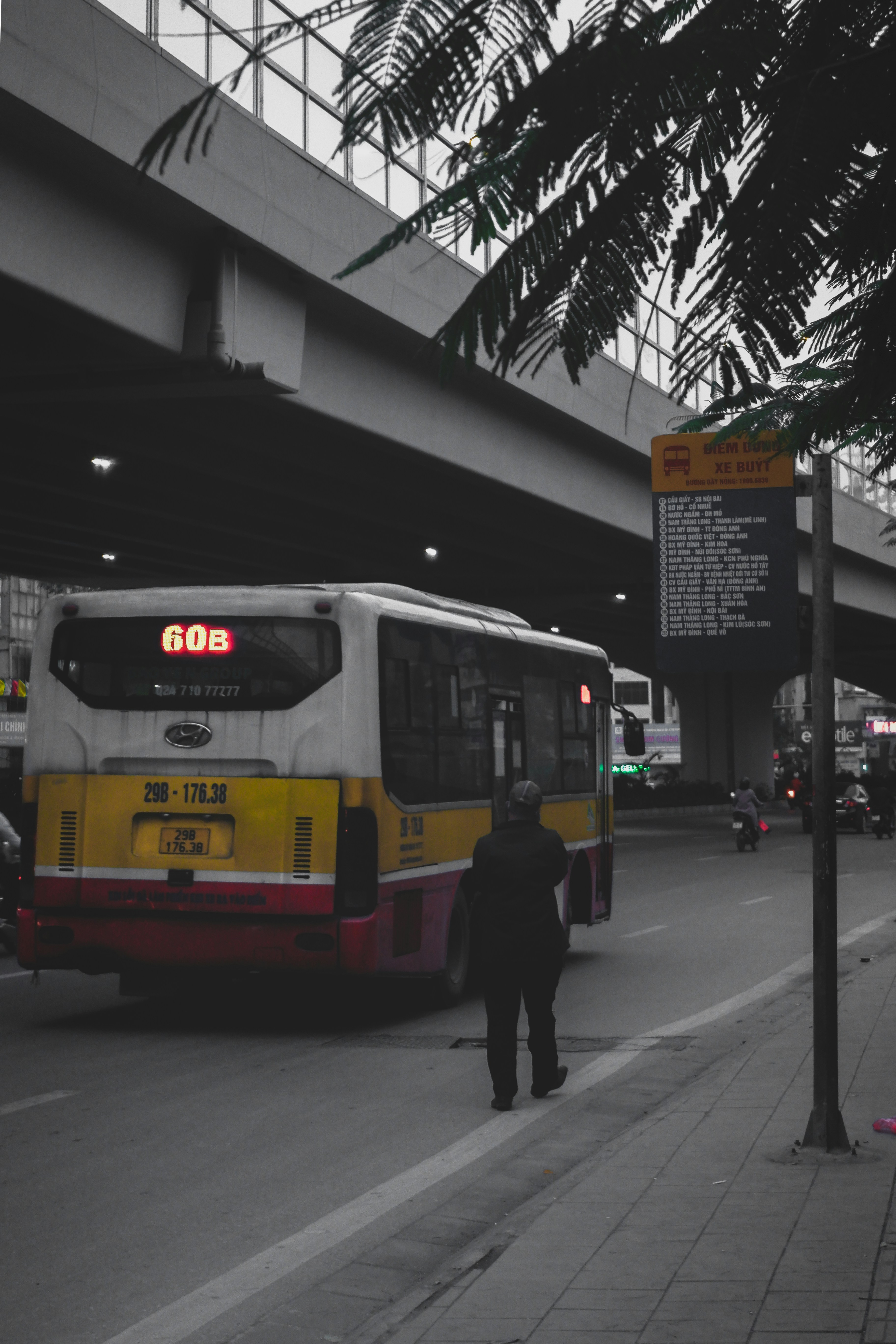 a yellow and white bus driving down a street