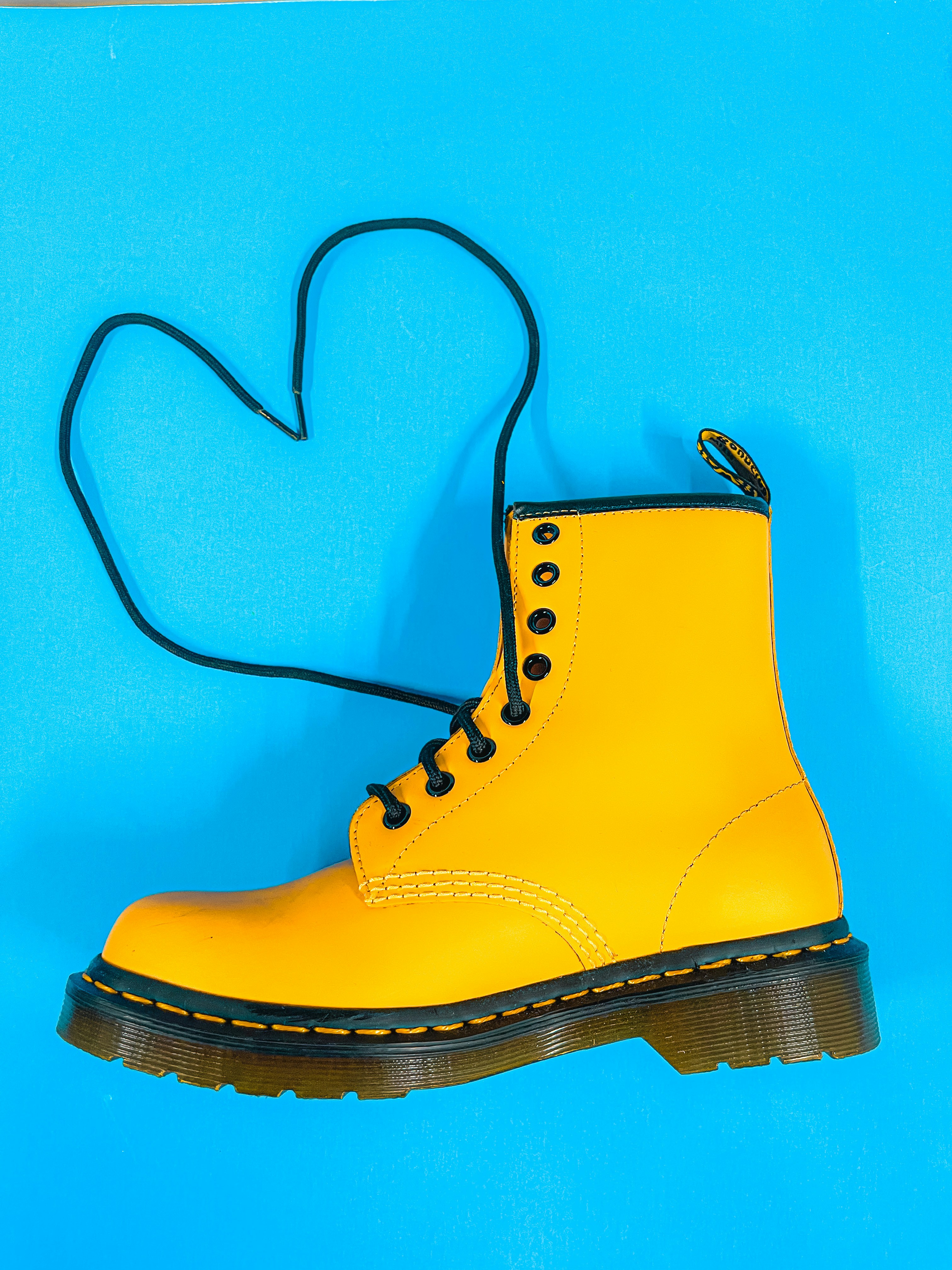 A pair of yellow boots on a blue background photo – Free Style Image on ...