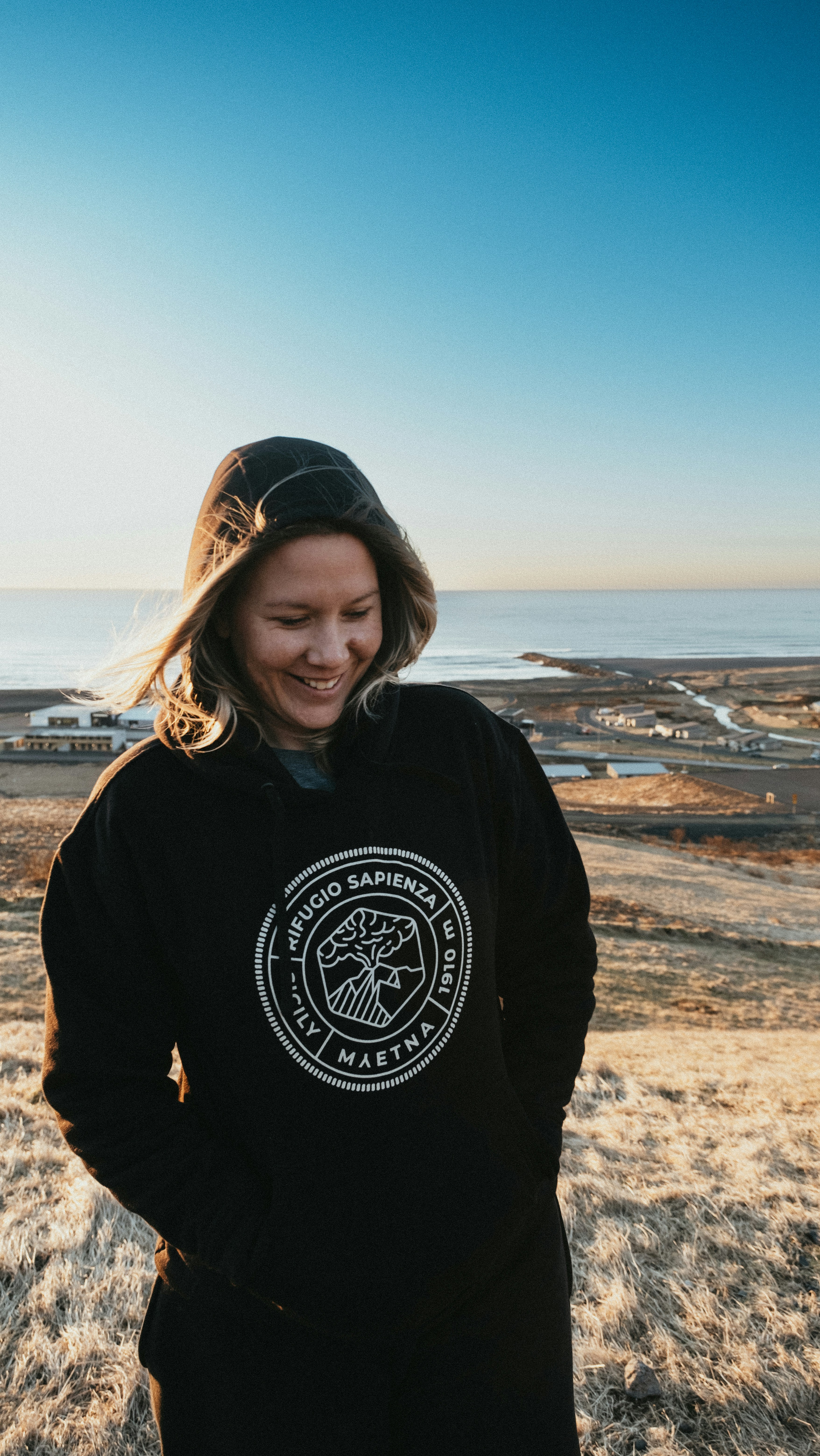 Wind-Kissed Portrait Over a Quiet Coastal Landscape at Sunset