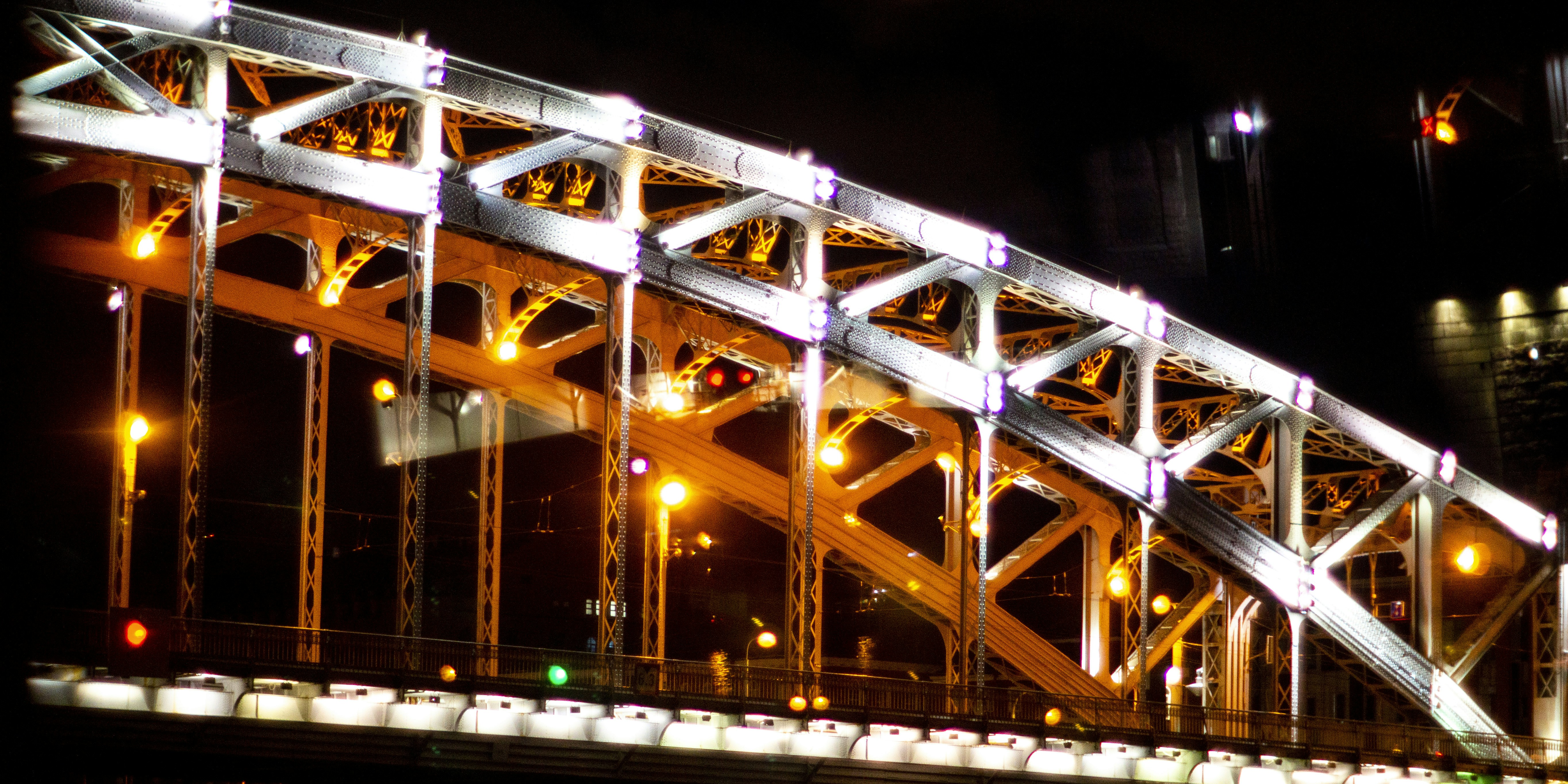 A bridge lit up at night with street lights photo – Free Saint ...