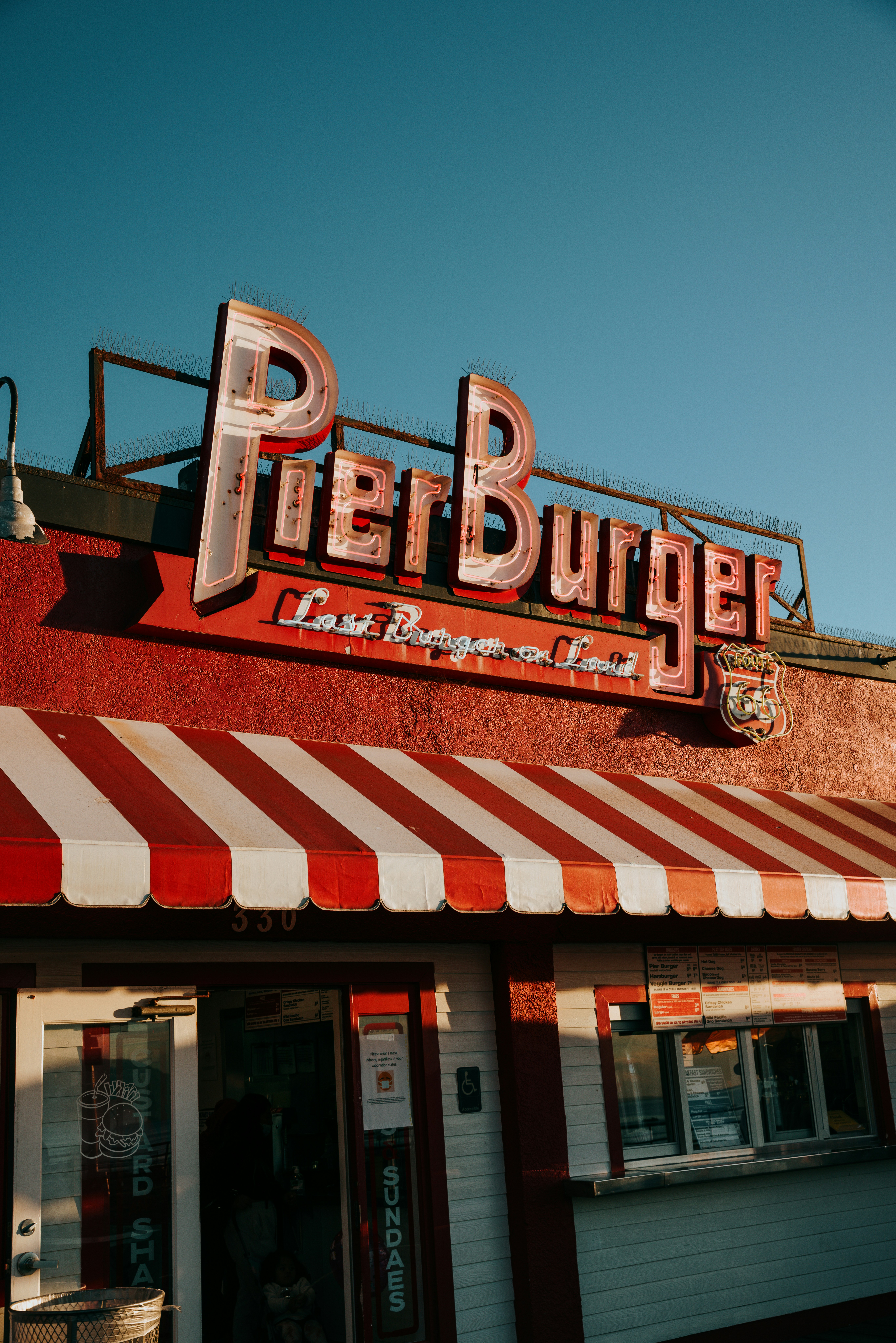 Neon Signage Over Red-and-White Awnings