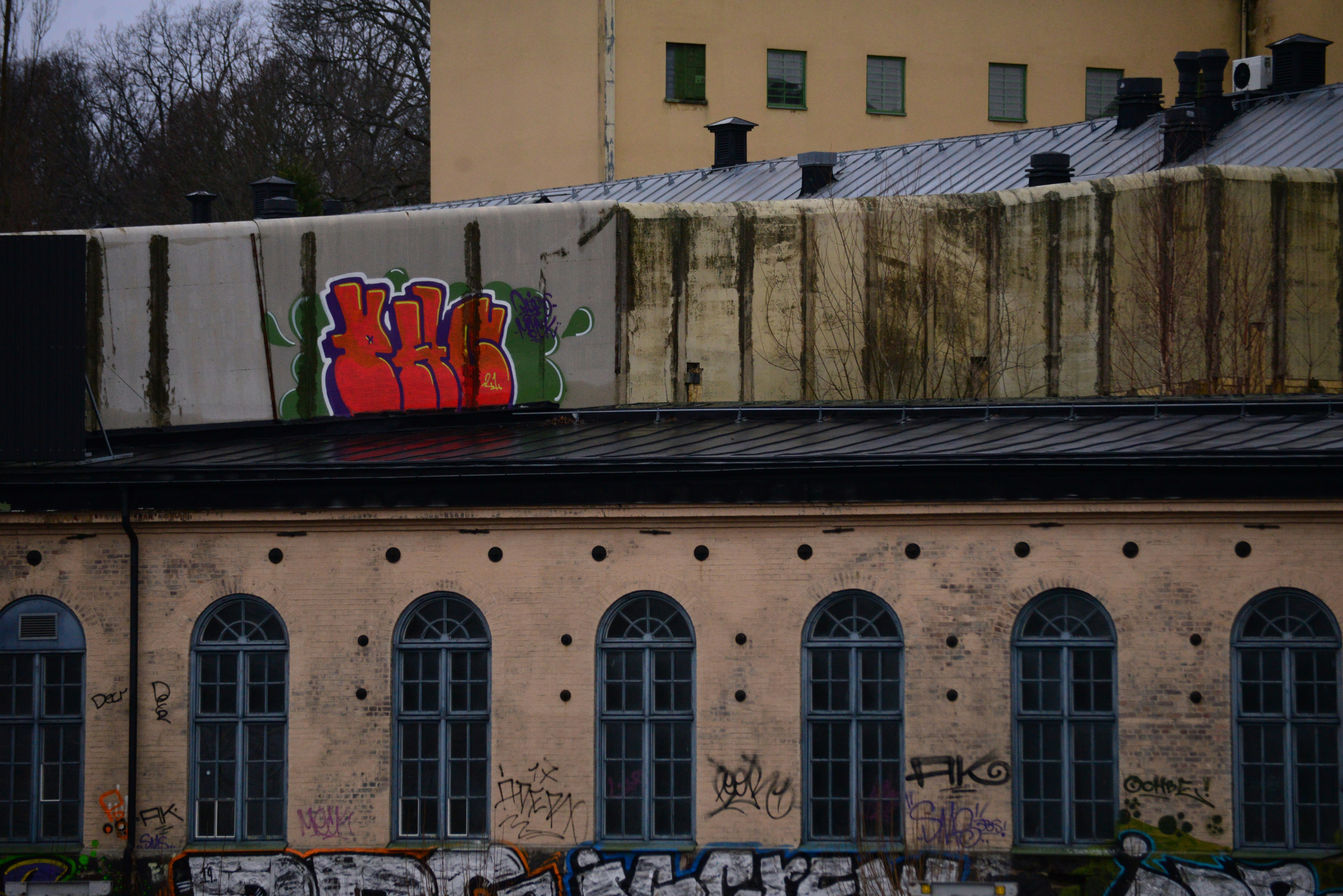 Crimson Tag Above Arched Facades: An Urban Graffiti Study