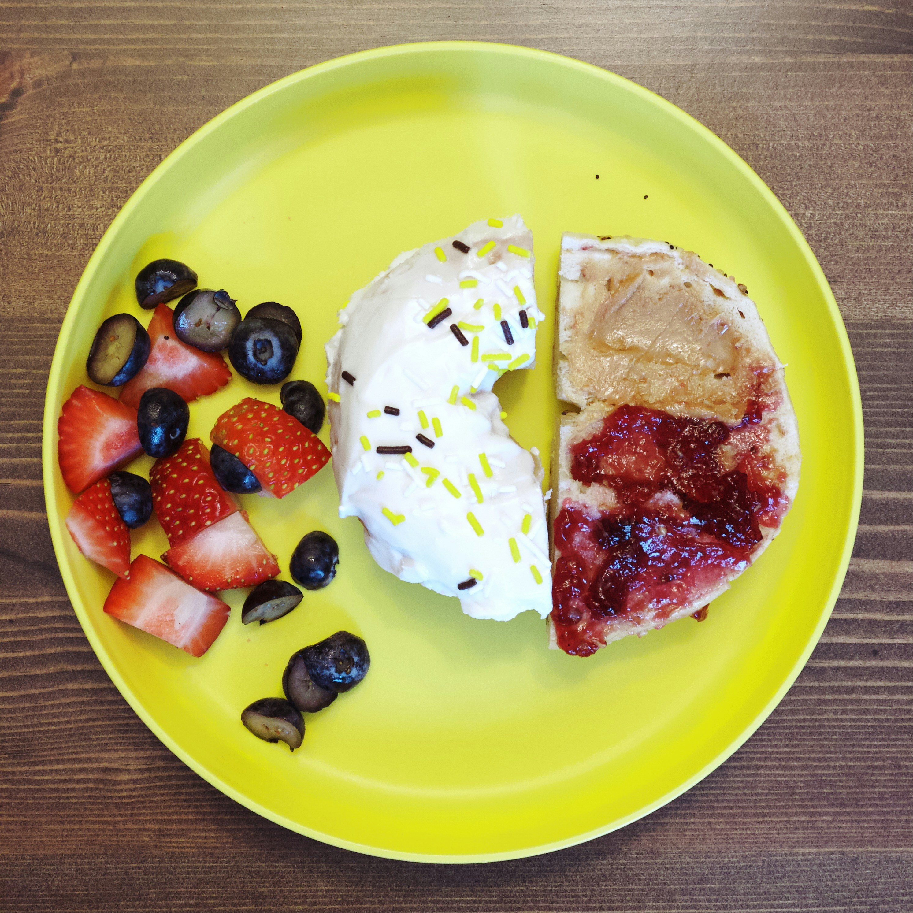 Sunlit Plate, Triple Treats: Berry Medley, Cream Puff, and Jam-Filled Pastry