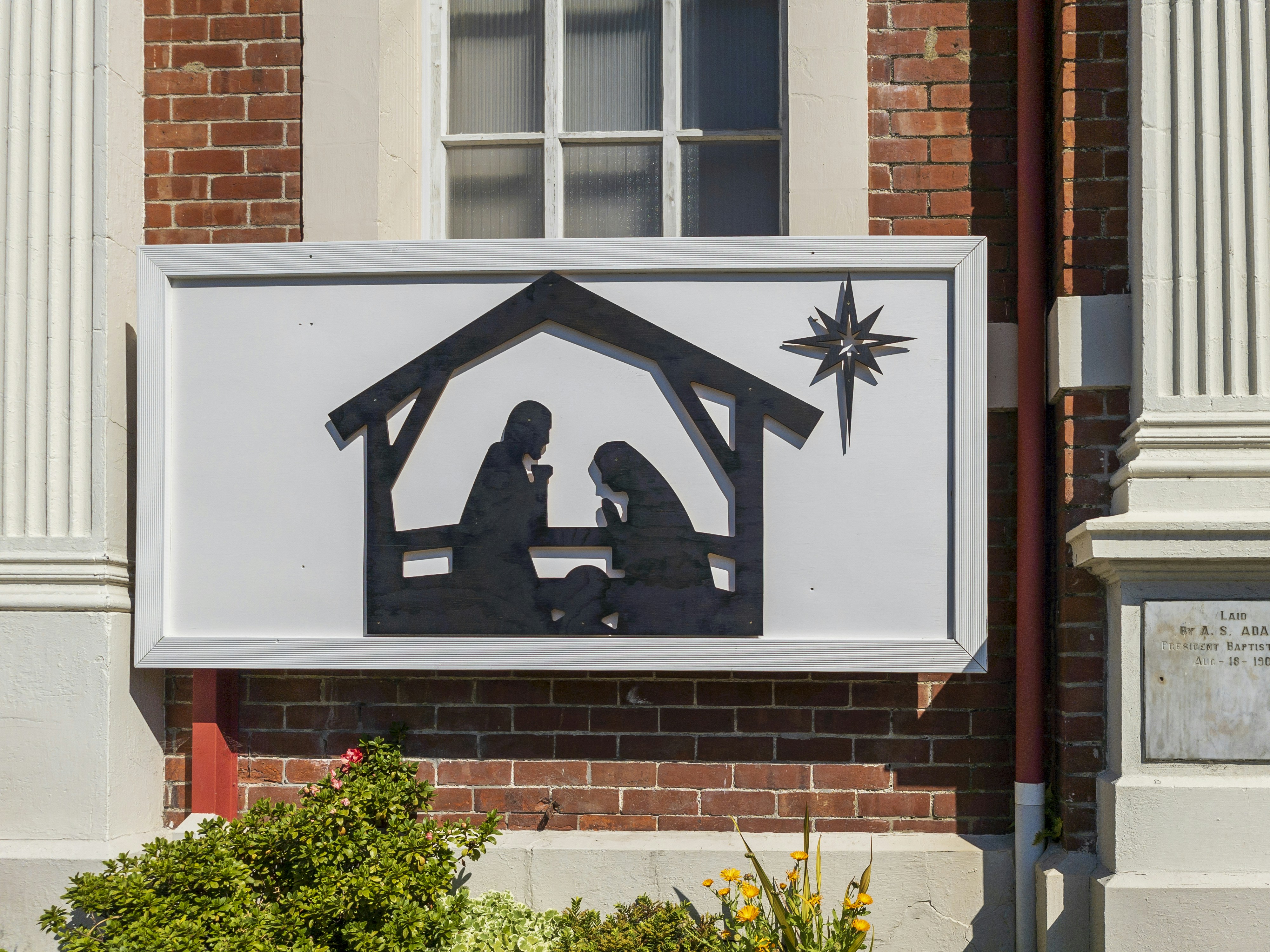 A nativity sign on the side of a building photo – Free Human Image on ...