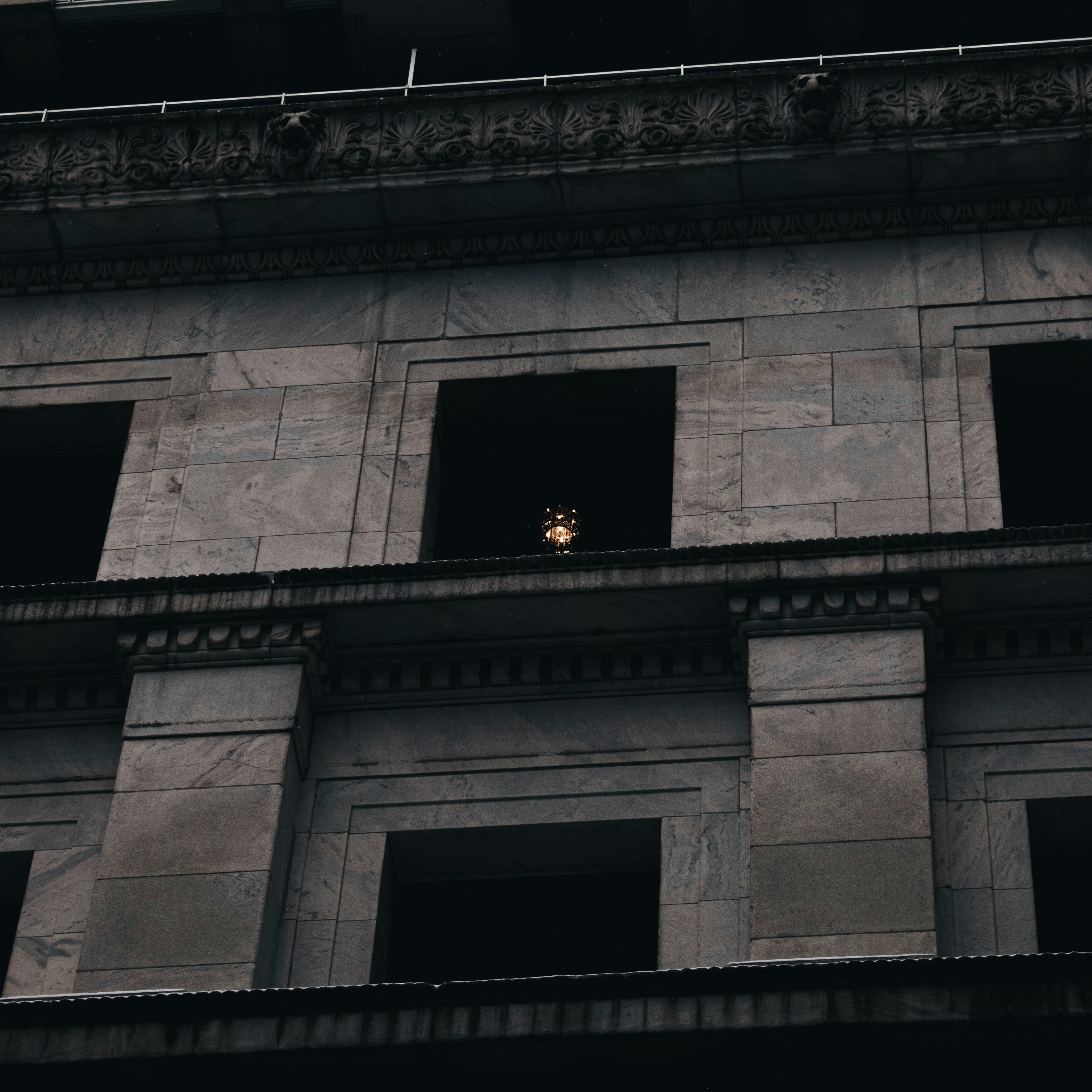 Lone Ember Through a Monochrome Facade