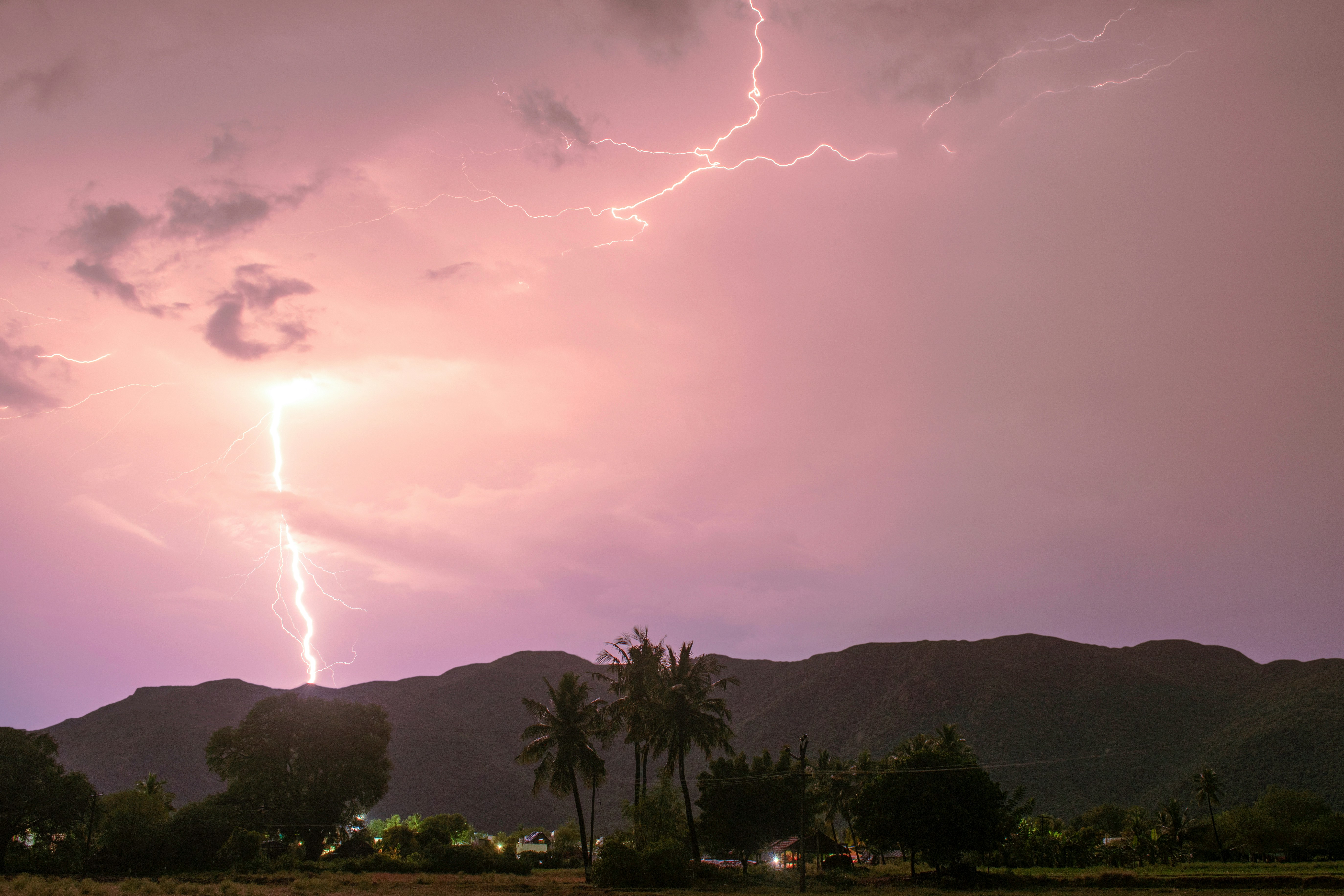 a lightning bolt hitting over a mountain range