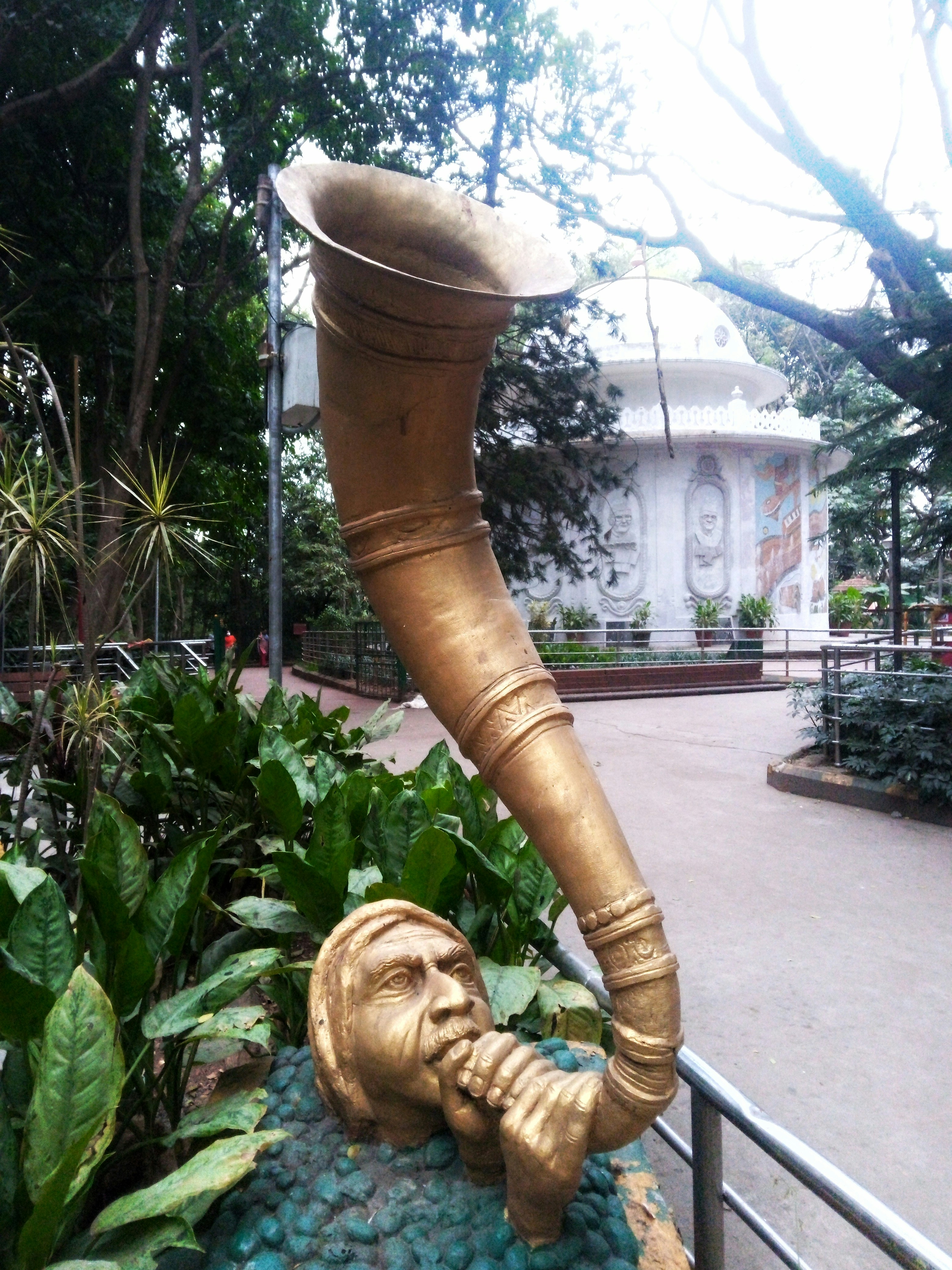 A statue of a man's head with a pipe sticking out of it photo – Free ...