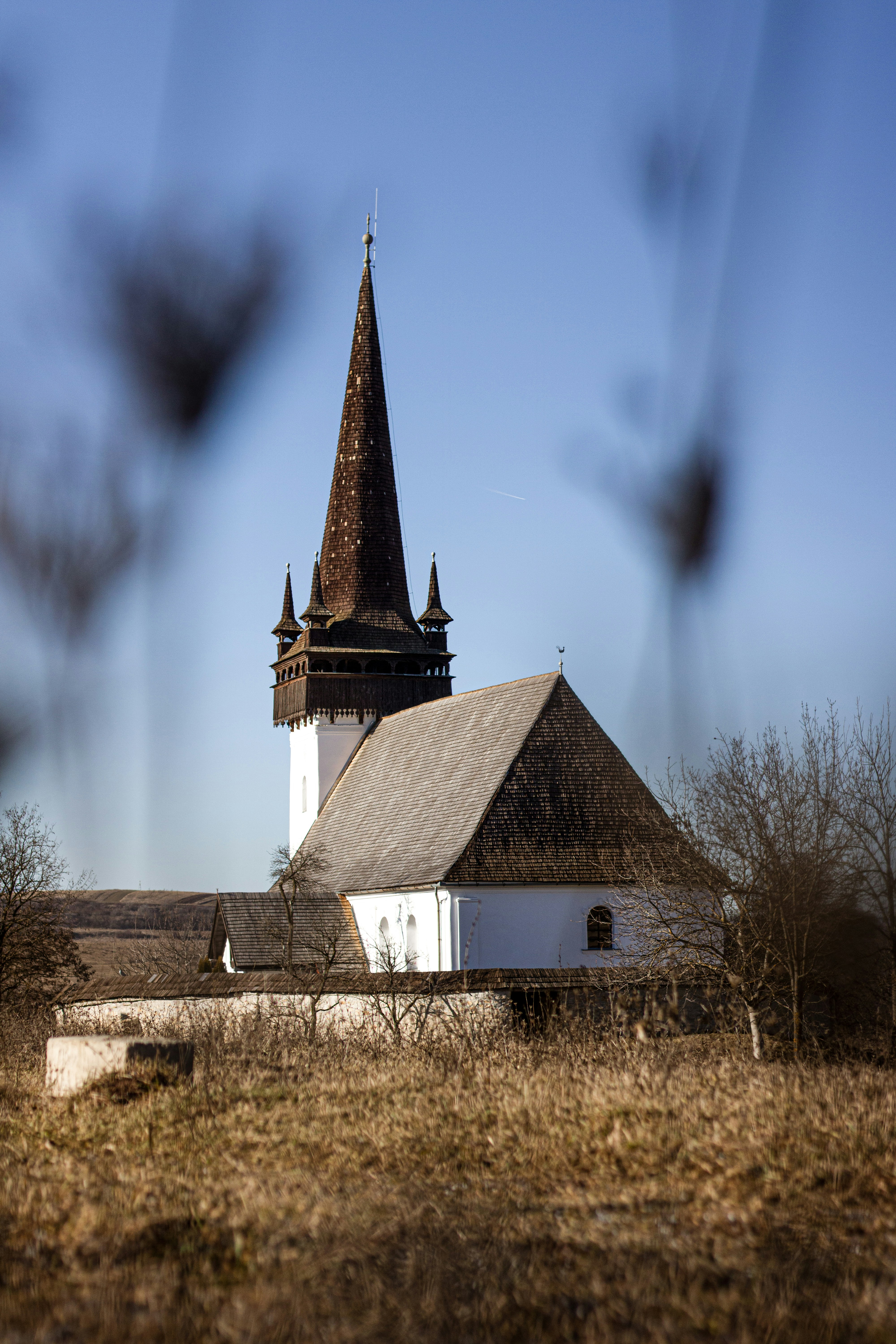Spire in Focus: A solitary chapel under a blue vastness