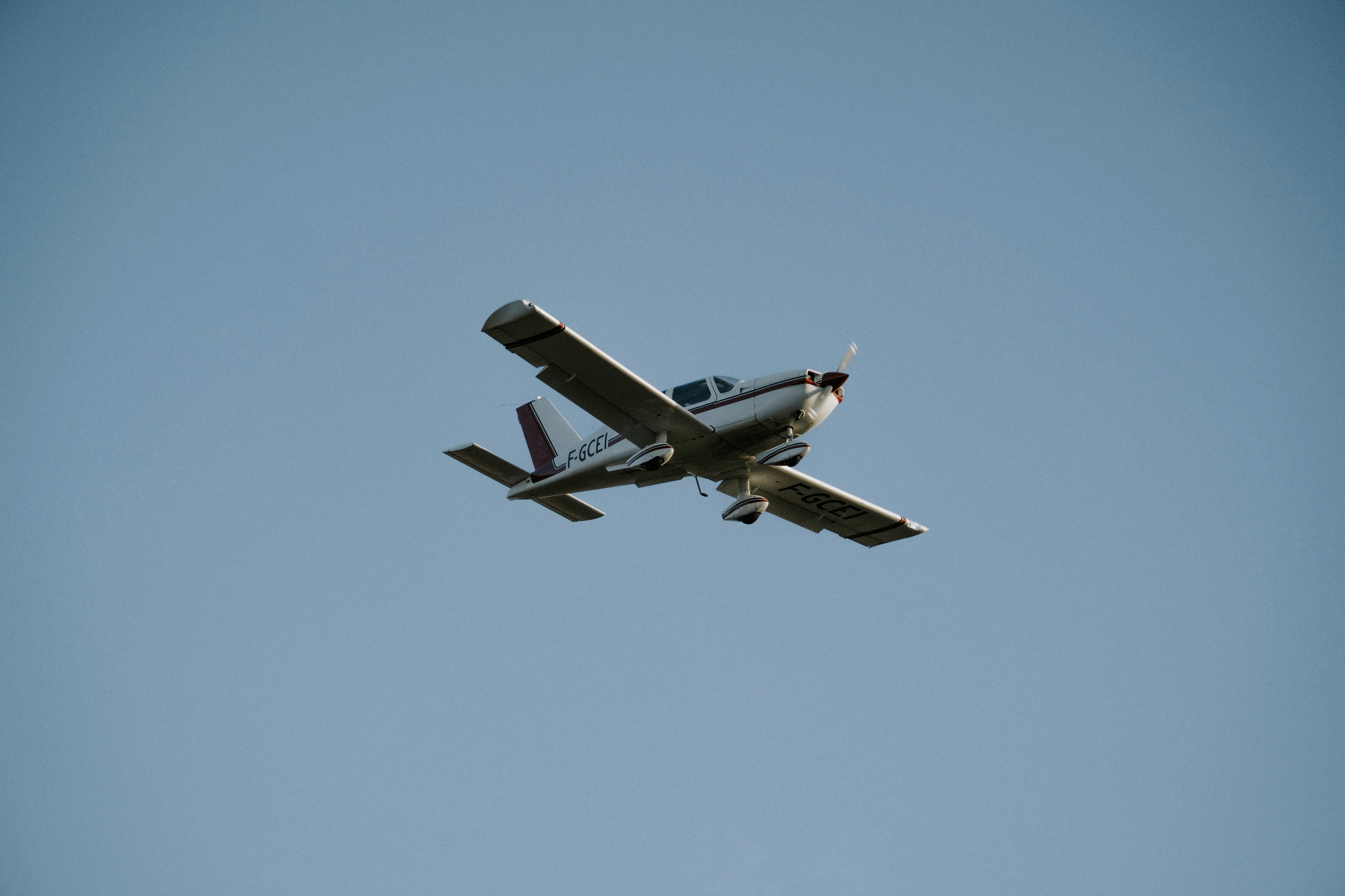 A small airplane flying through a blue sky photo – Free France Image on ...