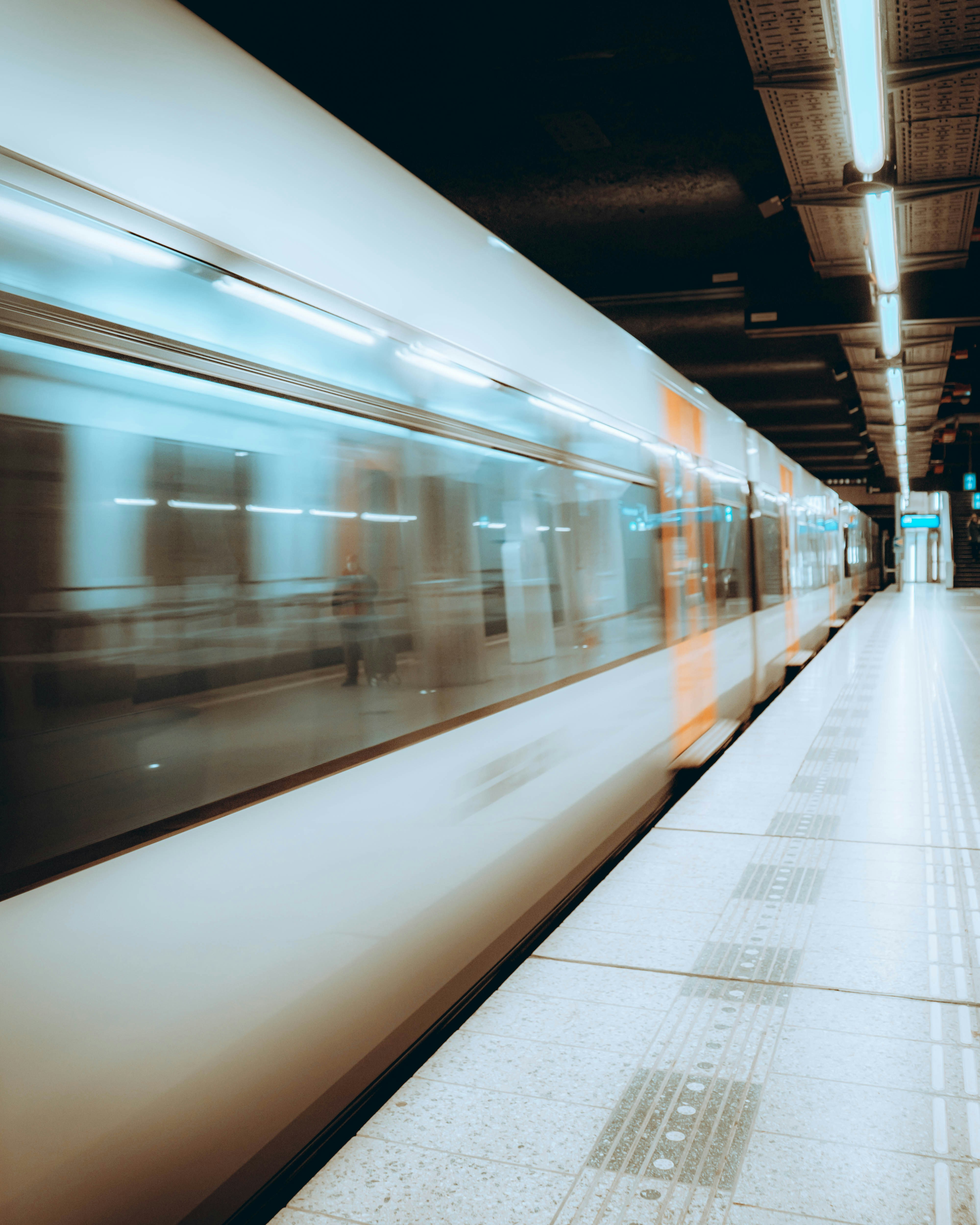 A train moving through a train station at night photo – Free Amsterdam ...