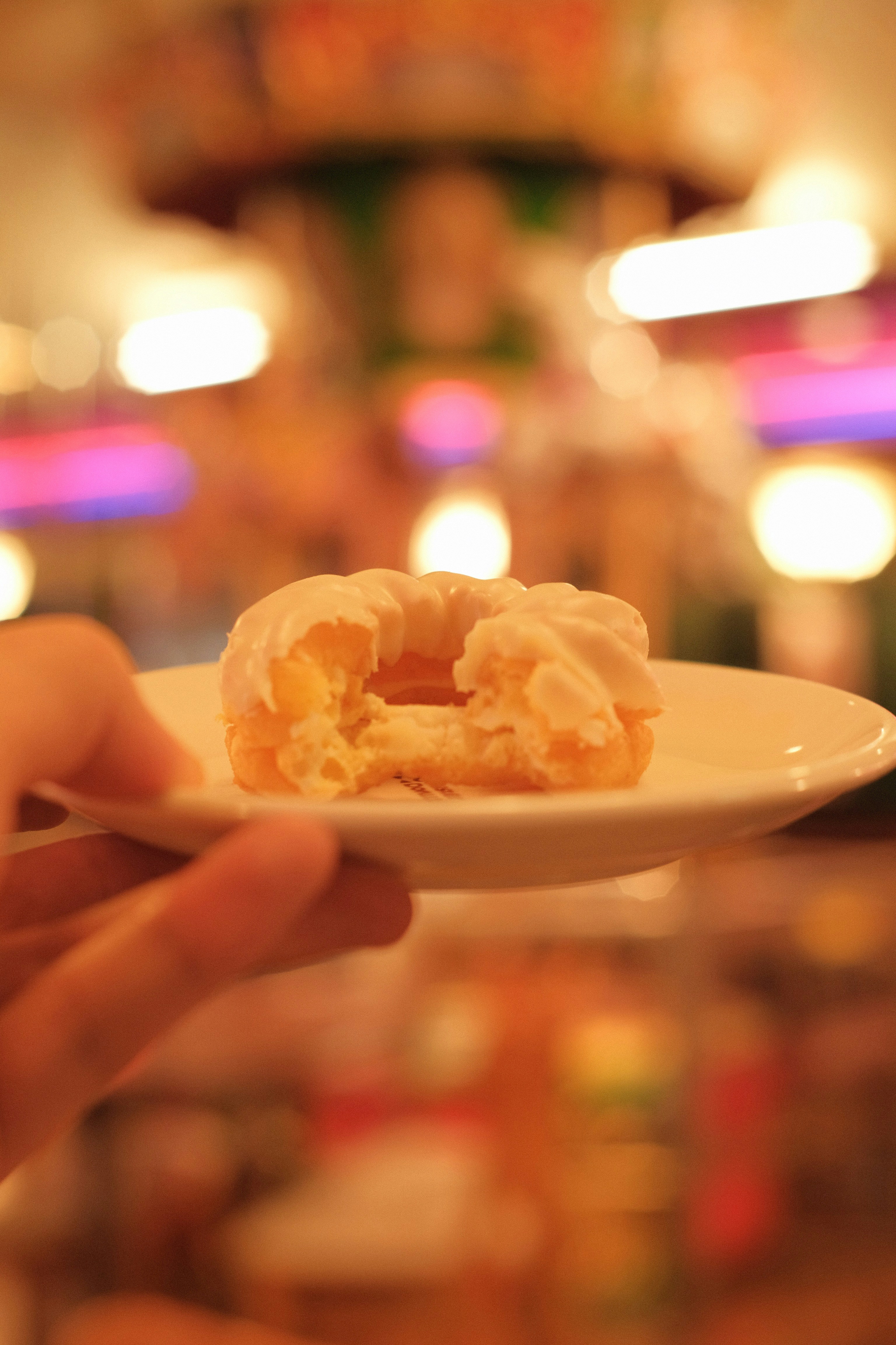 Donut on a Plate Bathed in Warm Neon Café Glow