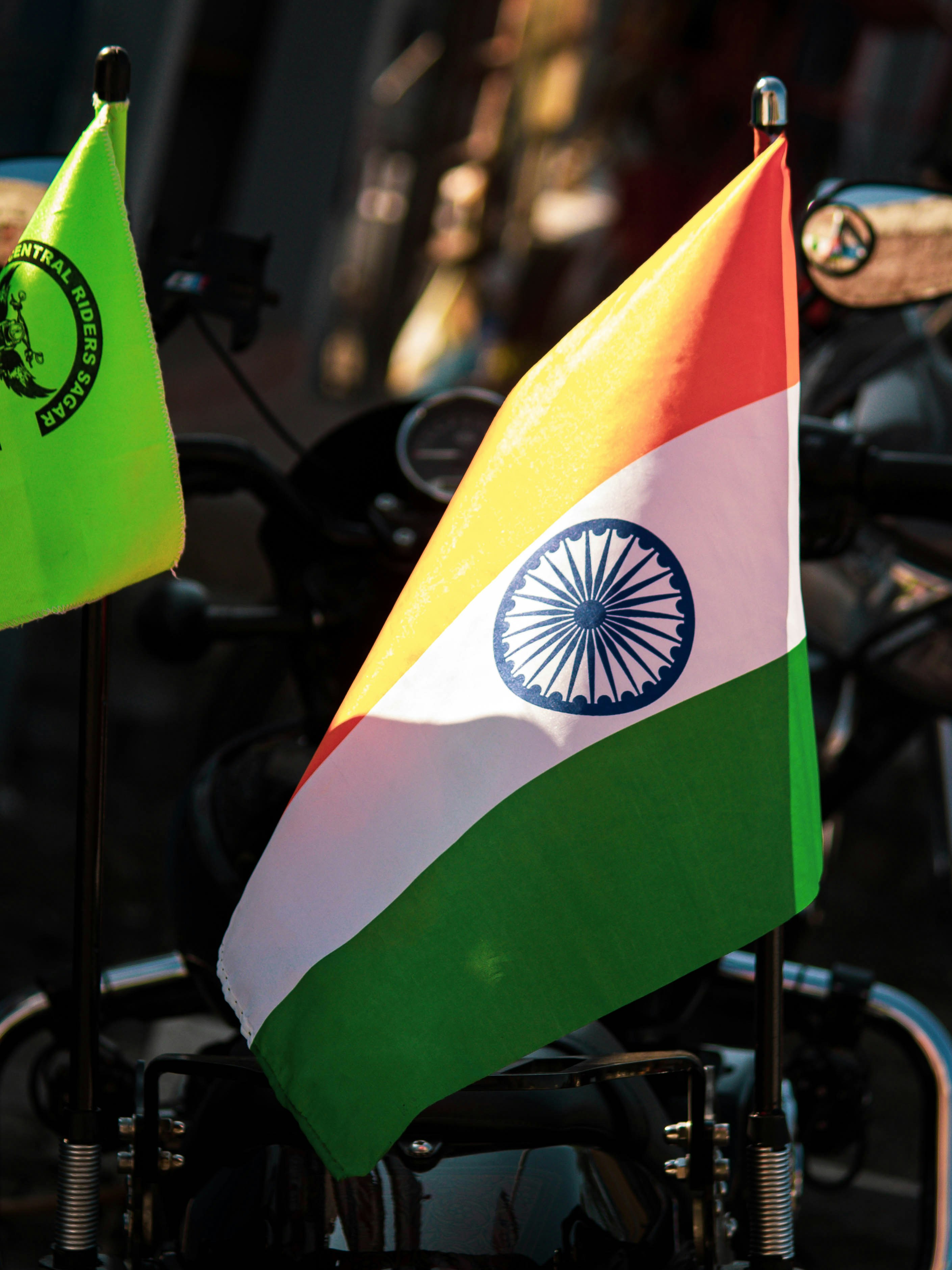 a couple of flags sitting on top of a motorcycle