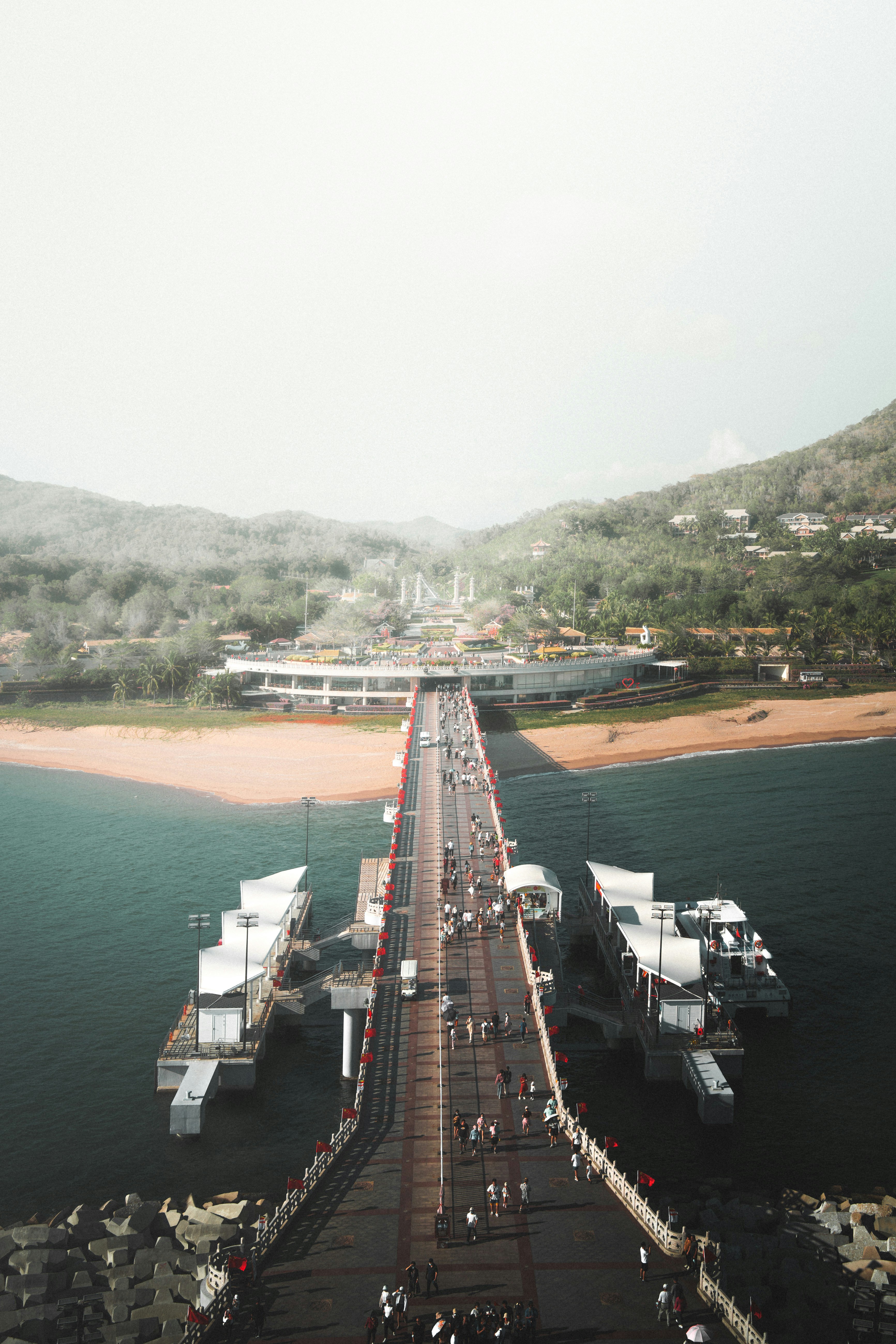 A very long bridge over a large body of water photo – Free ...