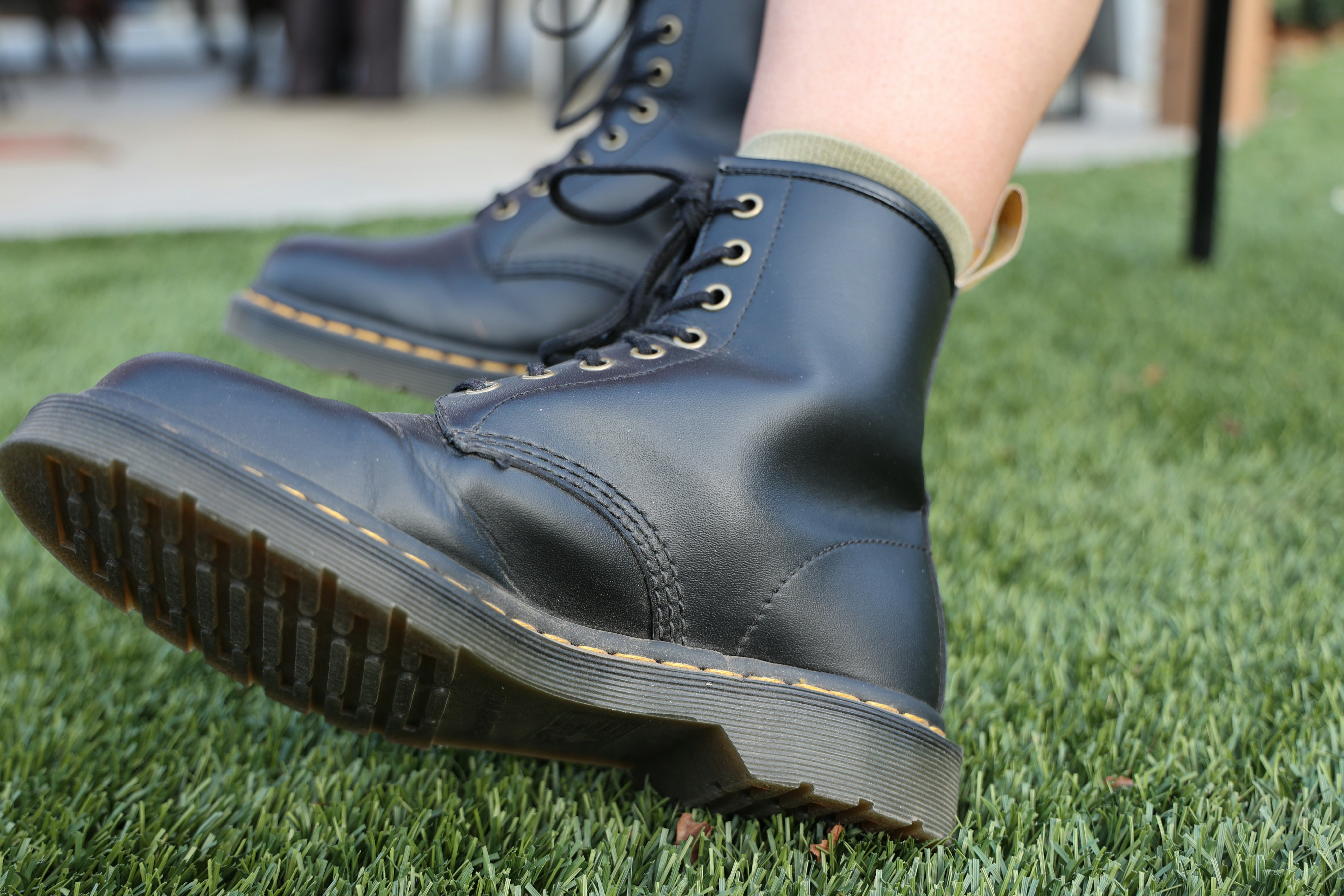 A close up of a person wearing black boots photo – Free Footwear Image ...
