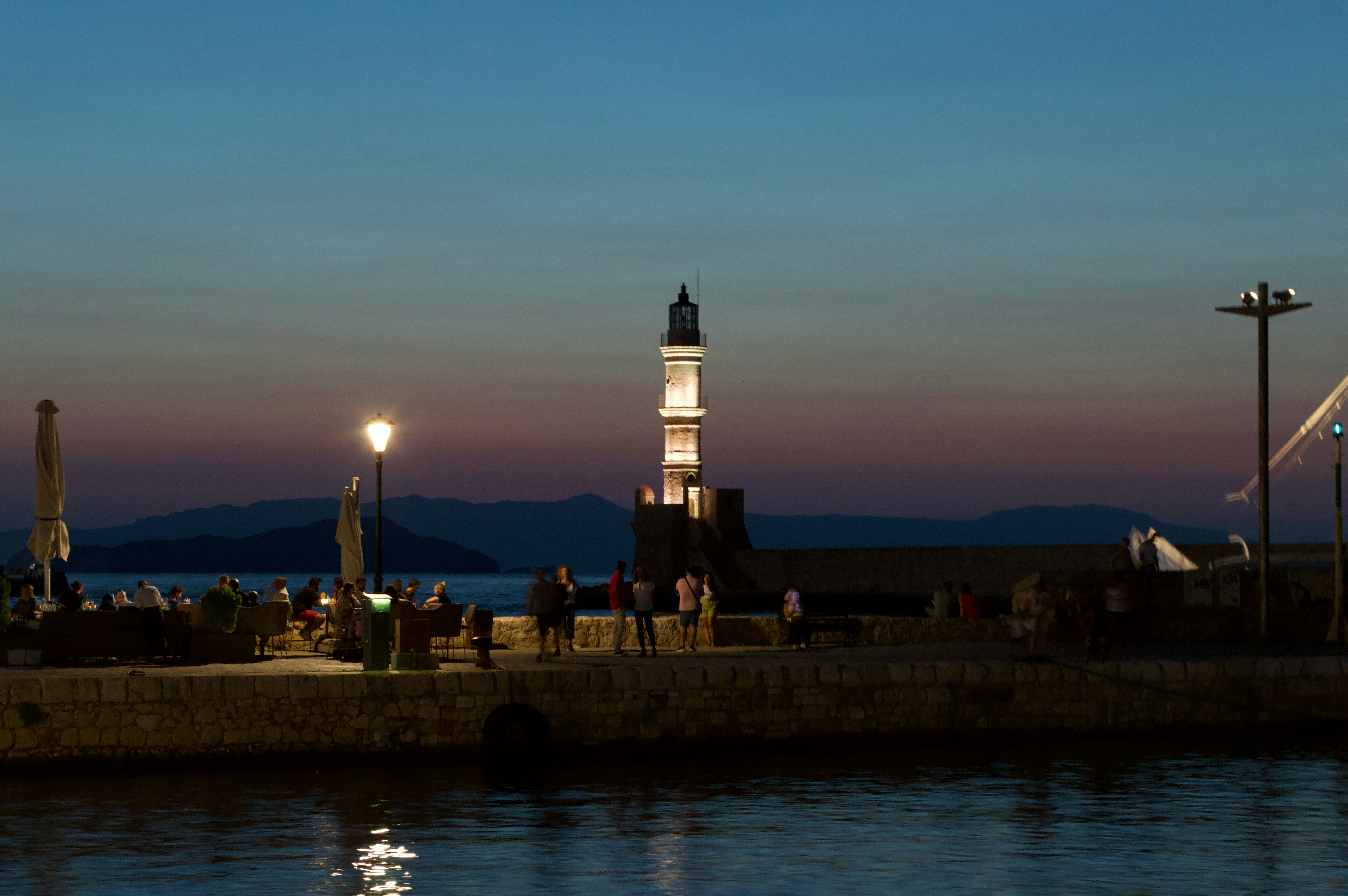 A clock tower sitting next to a body of water photo – Free Crete Image ...