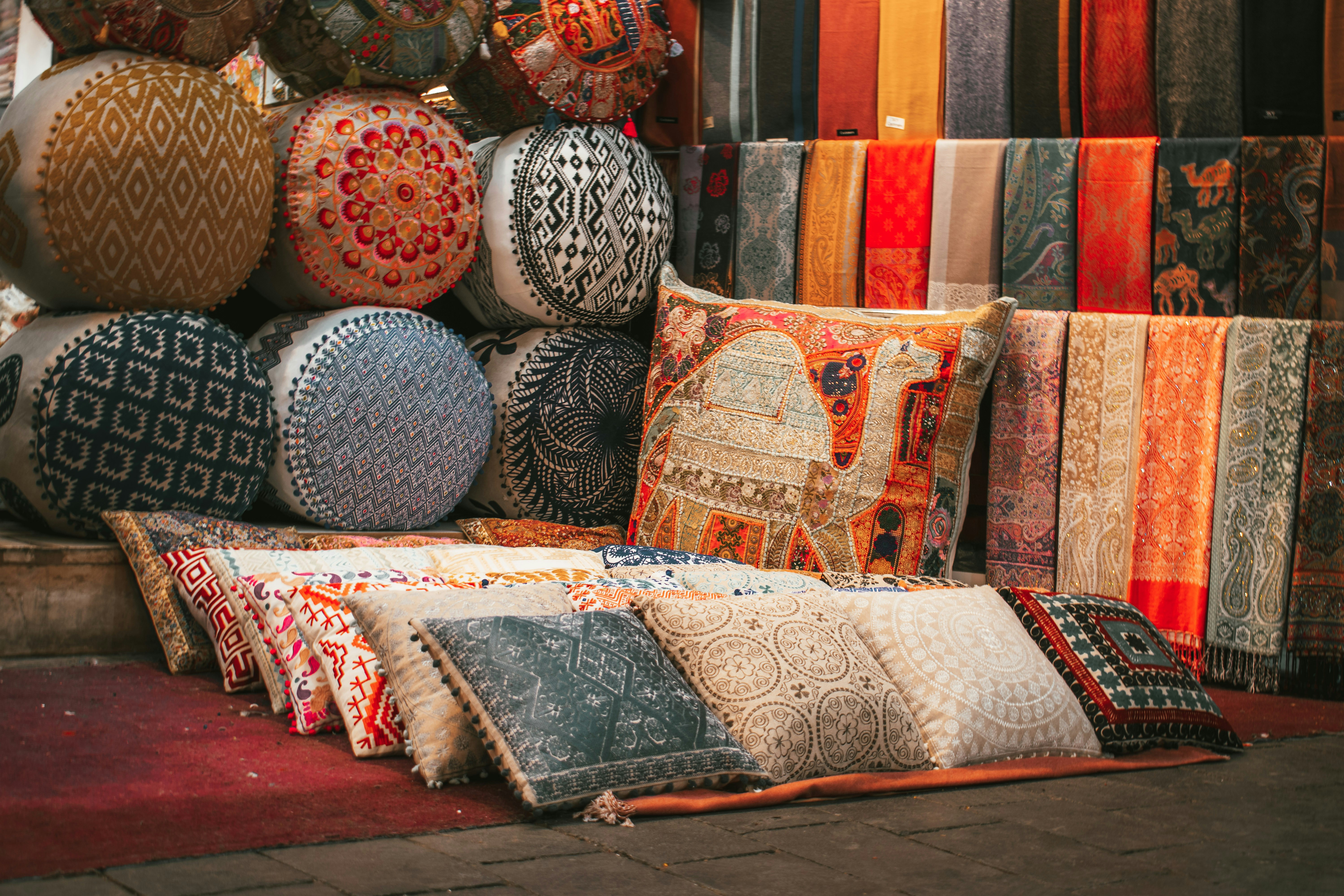 A bunch of pillows that are on the ground photo – Free Cushion Image on ...