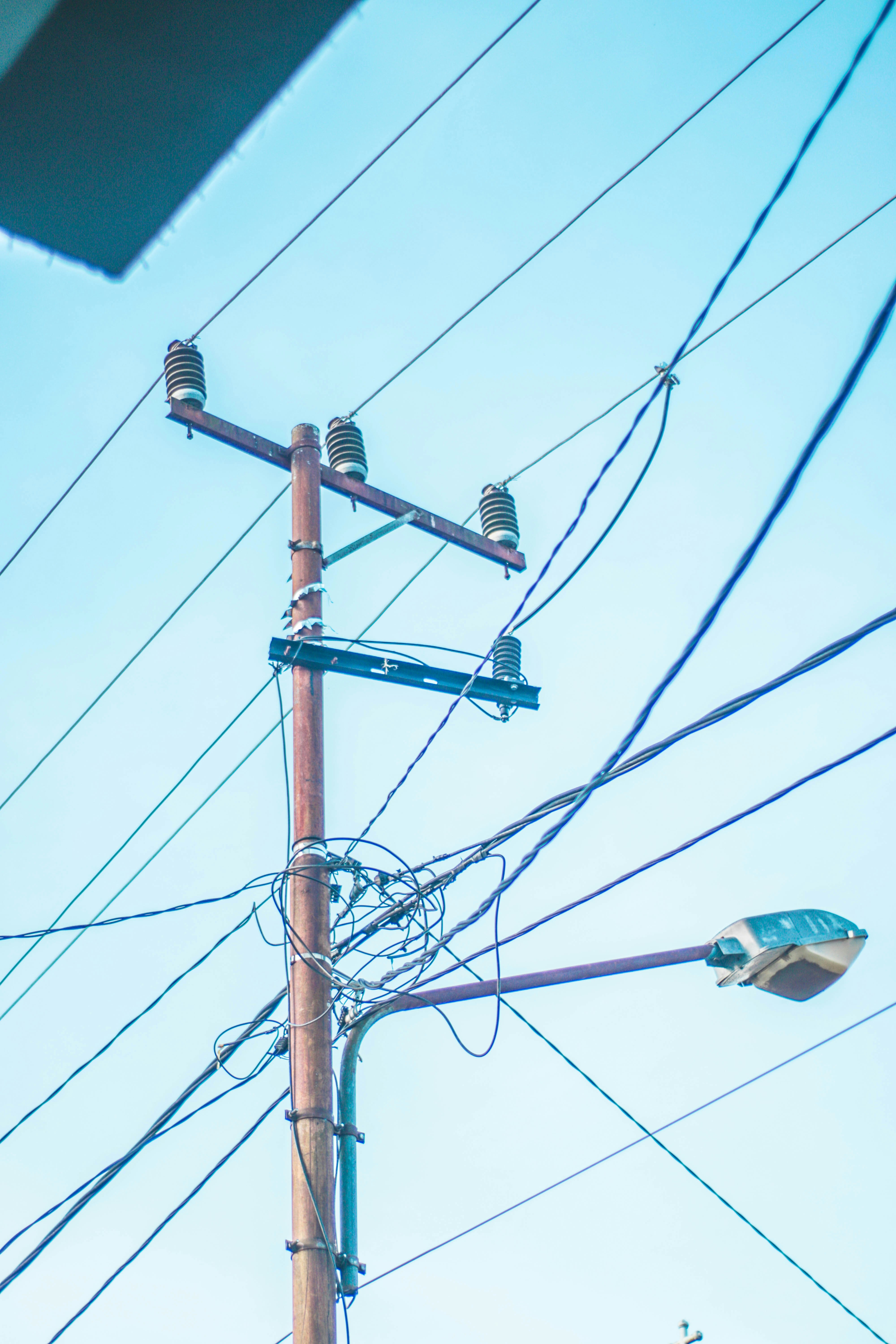 A telephone pole with a bunch of wires attached to it photo – Free ...
