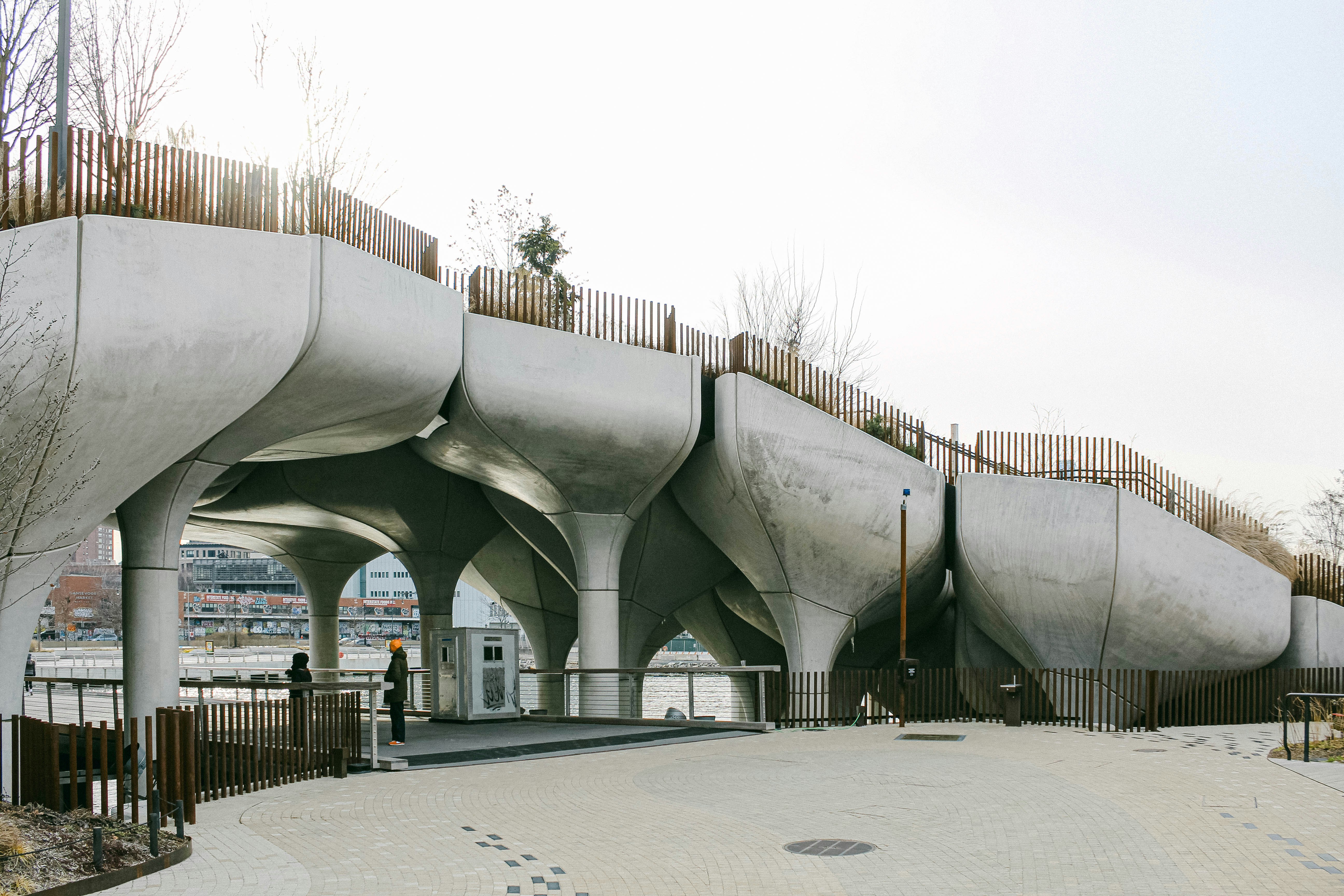 a large concrete structure with a wooden fence around it