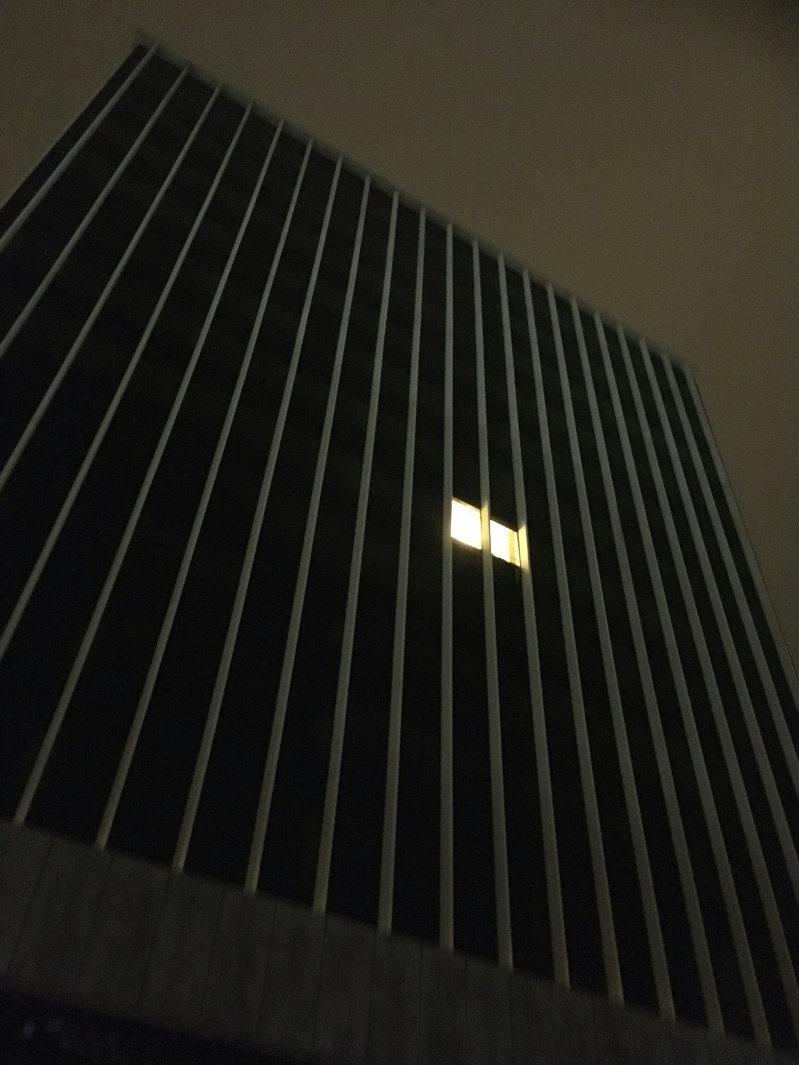 a tall building with a street light in the middle of it