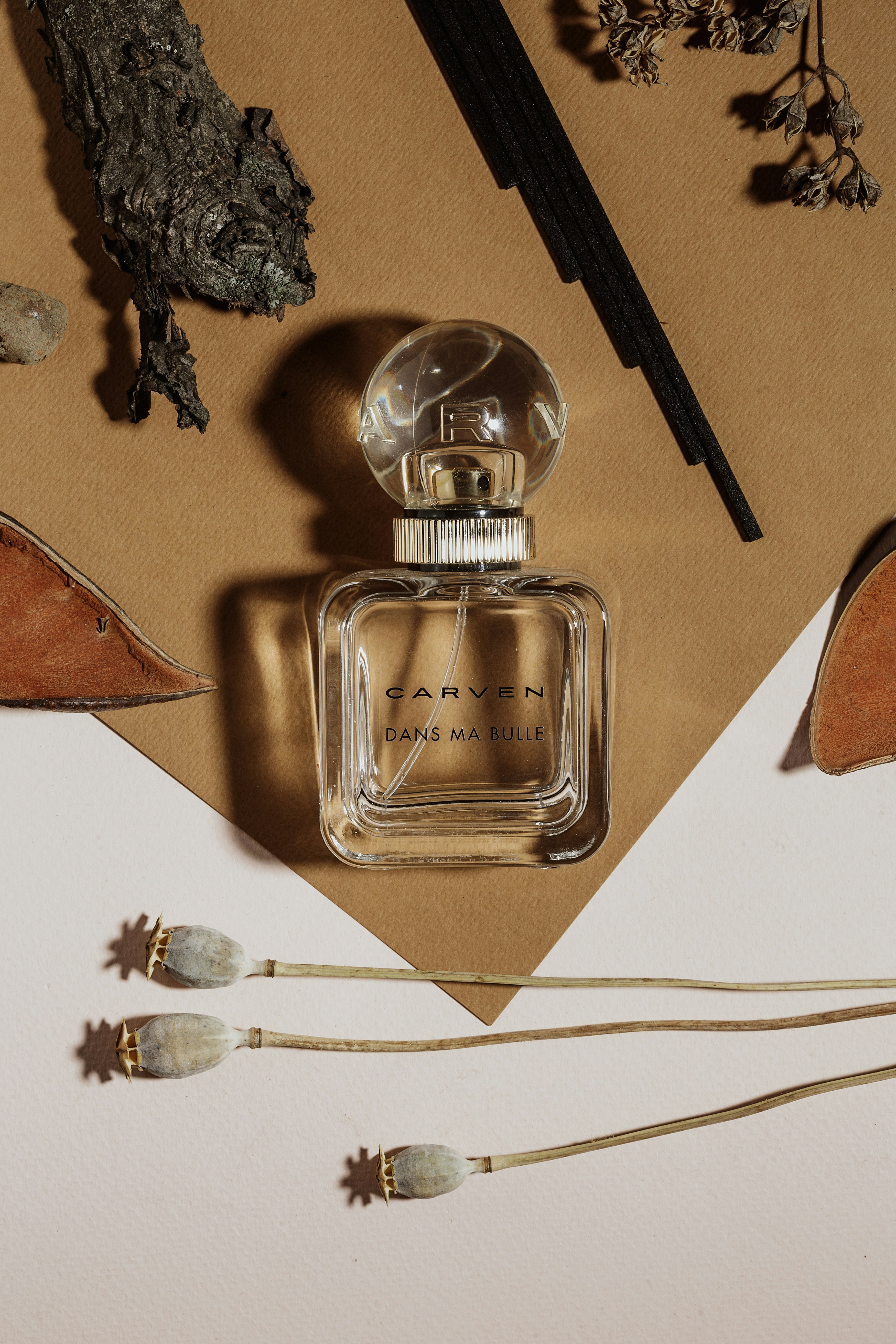 Carven on a Geometric Stage: Perfume Bottle Framed by Botanicals