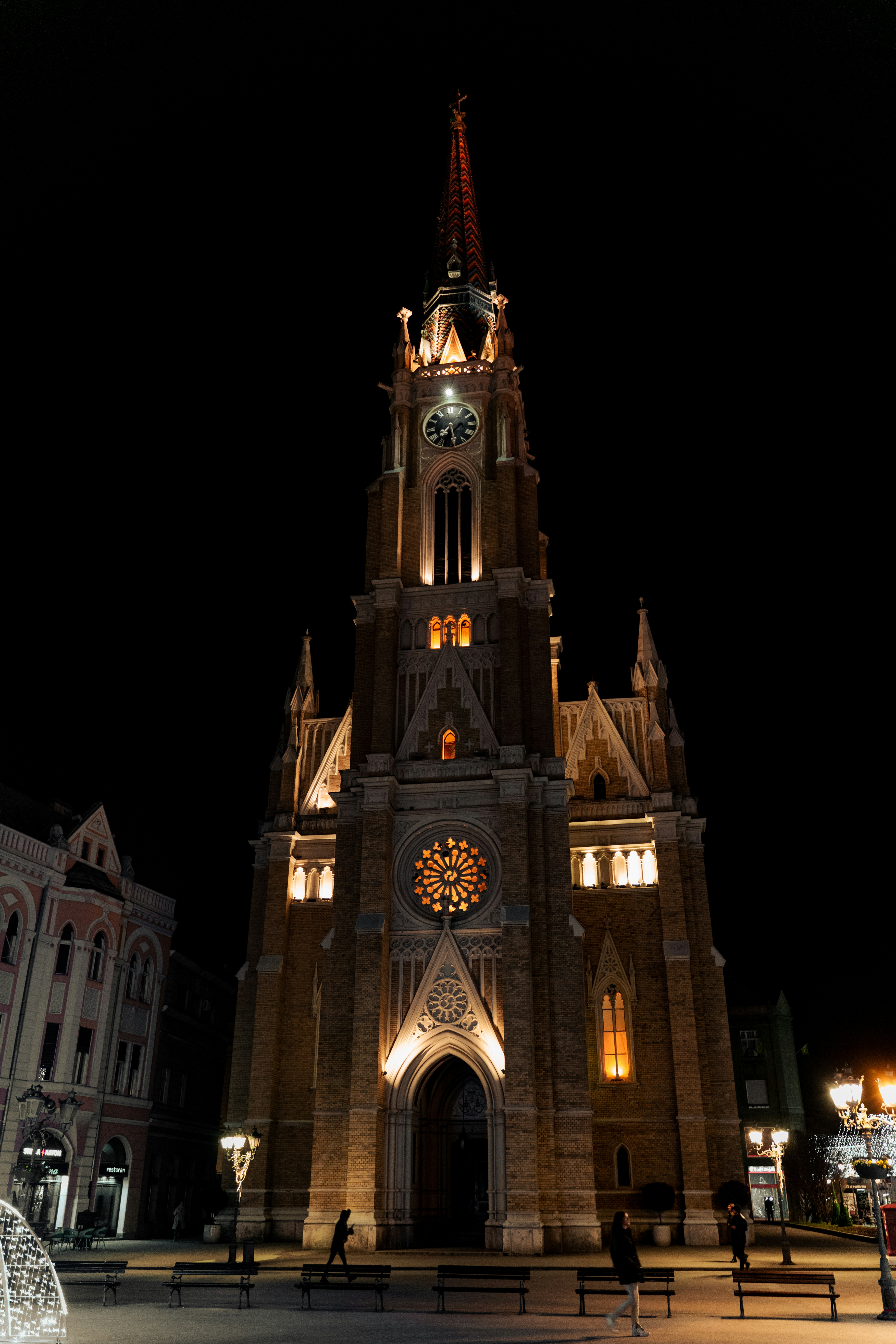Night-lit Rose: A Gothic Cathedral's Central Glow from Spire to Rose Window