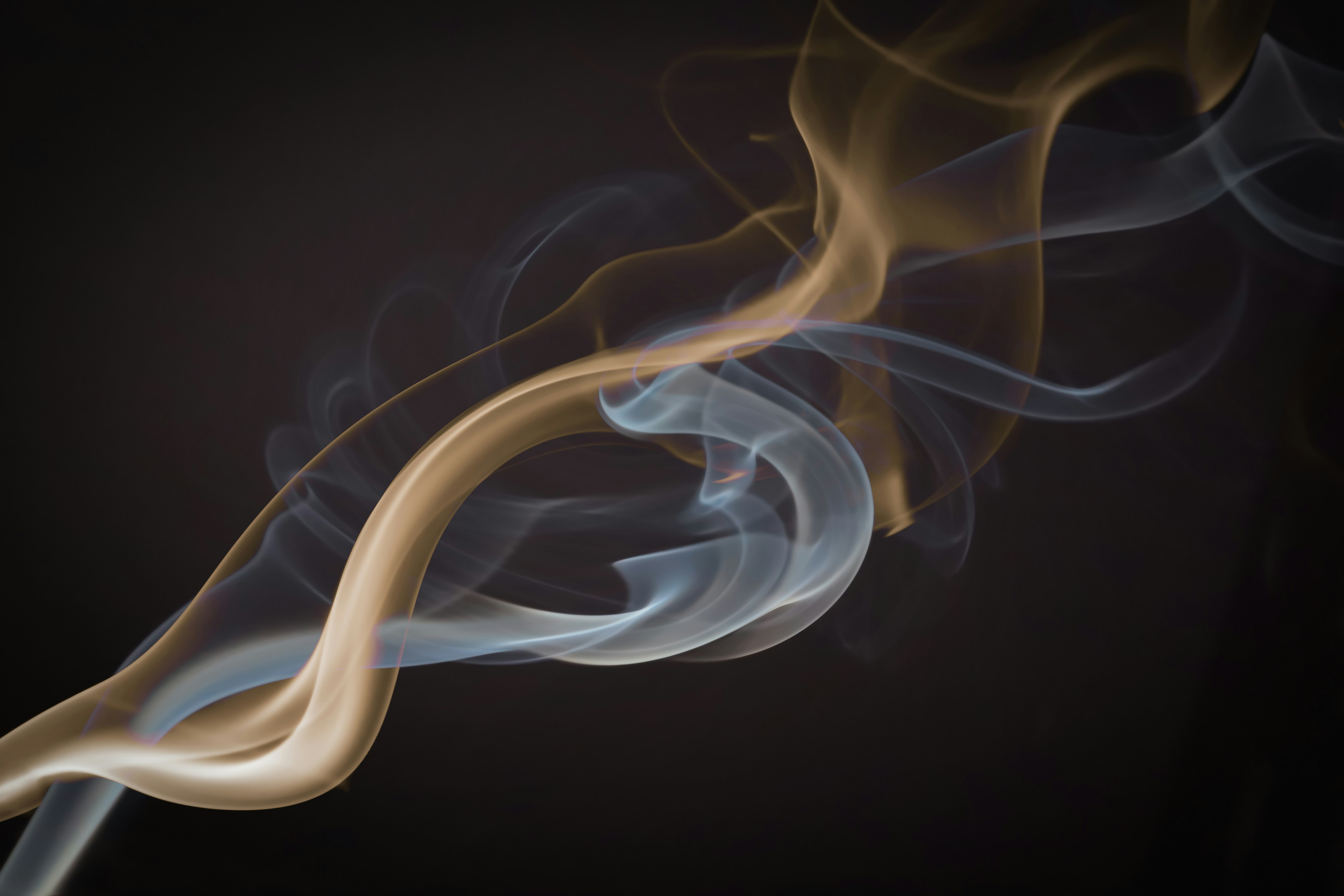 the smoke is white and brown on the black background