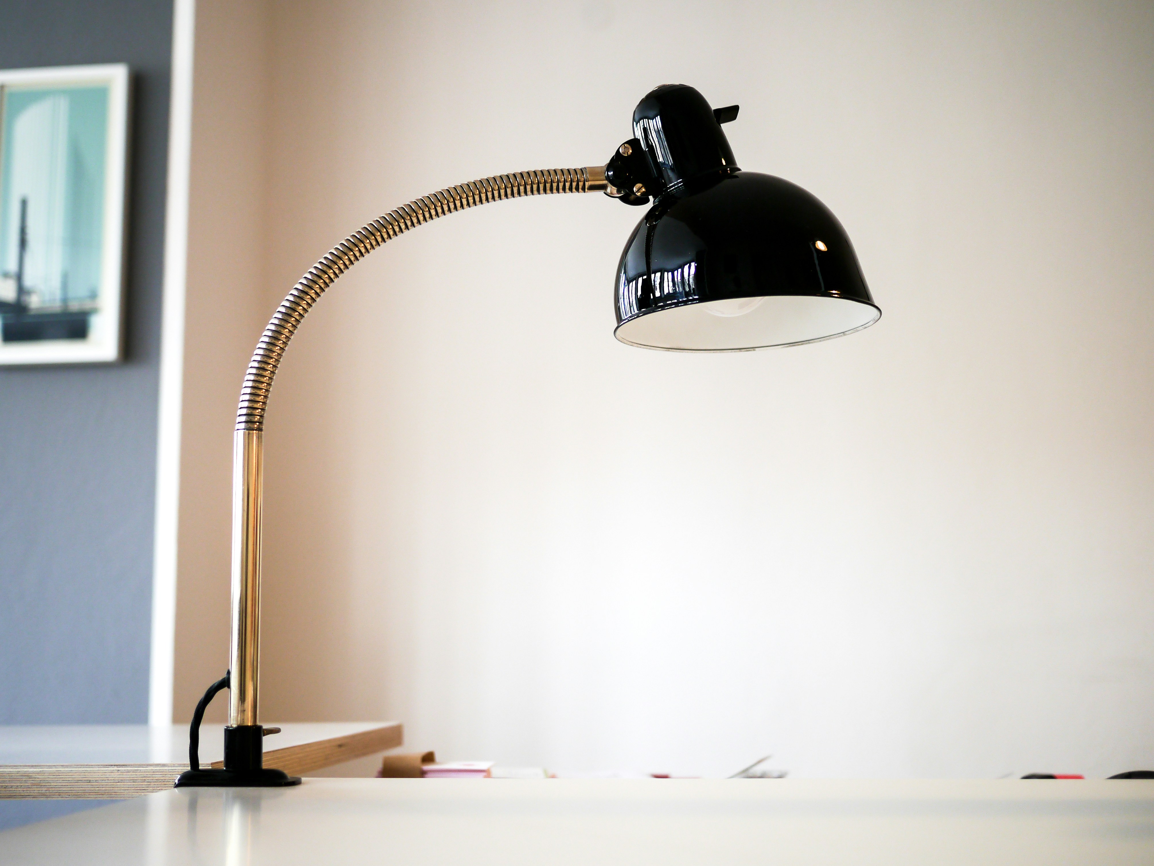 A desk lamp sitting on top of a wooden desk photo – Free Weimar Image ...
