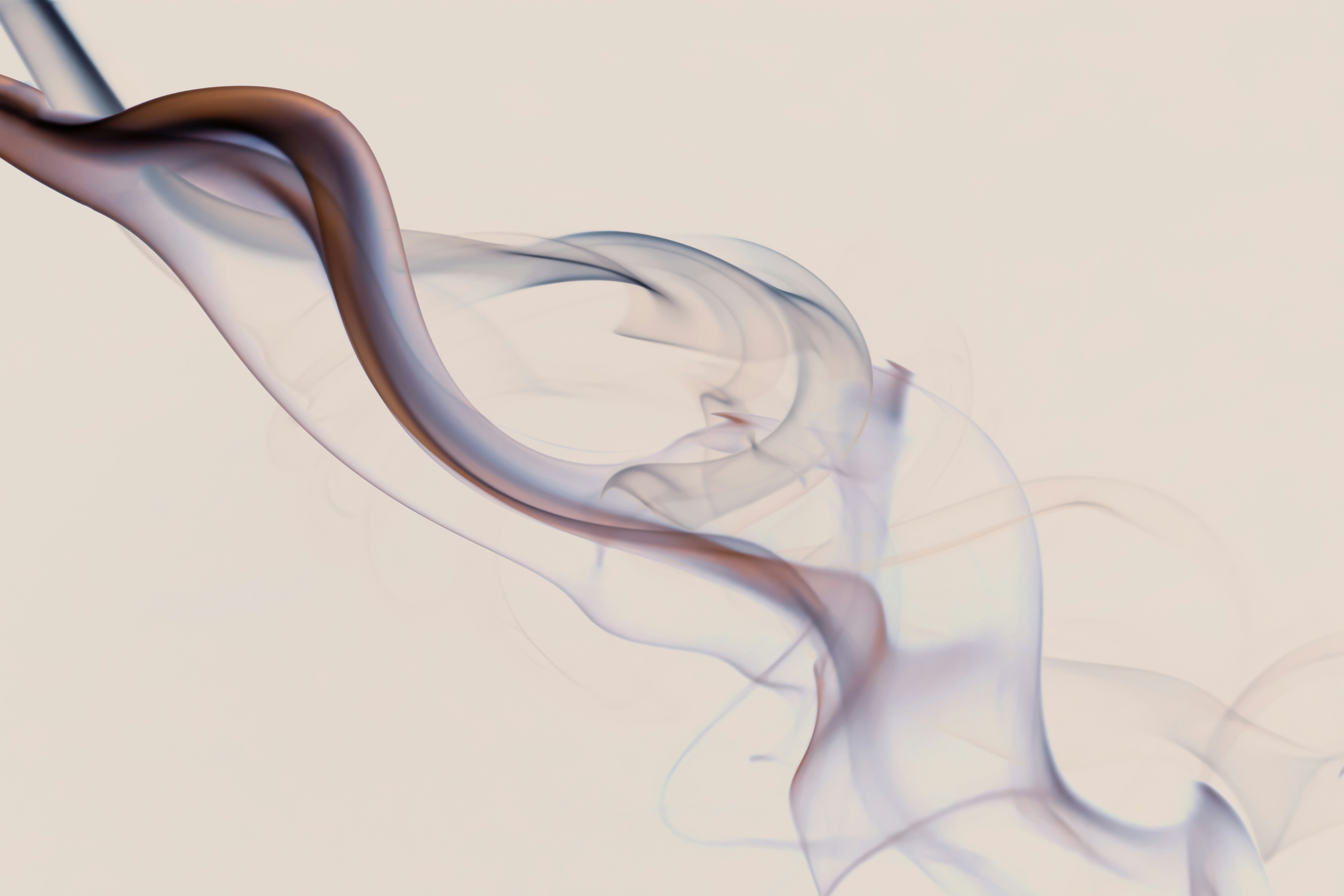 Abstract swirls of smoke intertwine gracefully against a soft backdrop, evoking a sense of fluidity and movement.