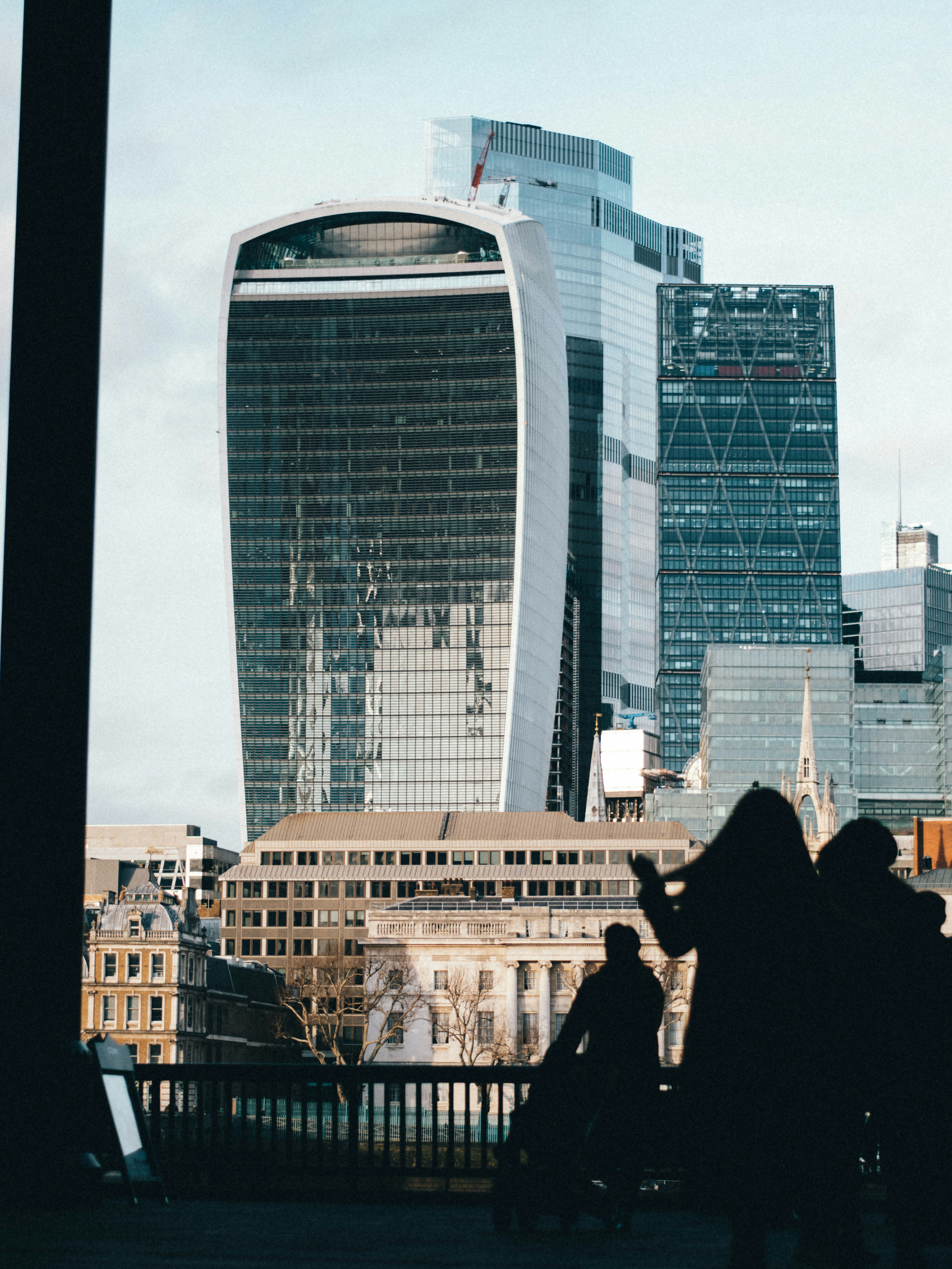 Two people sitting on a bench in front of a cityscape photo – Free Uk ...