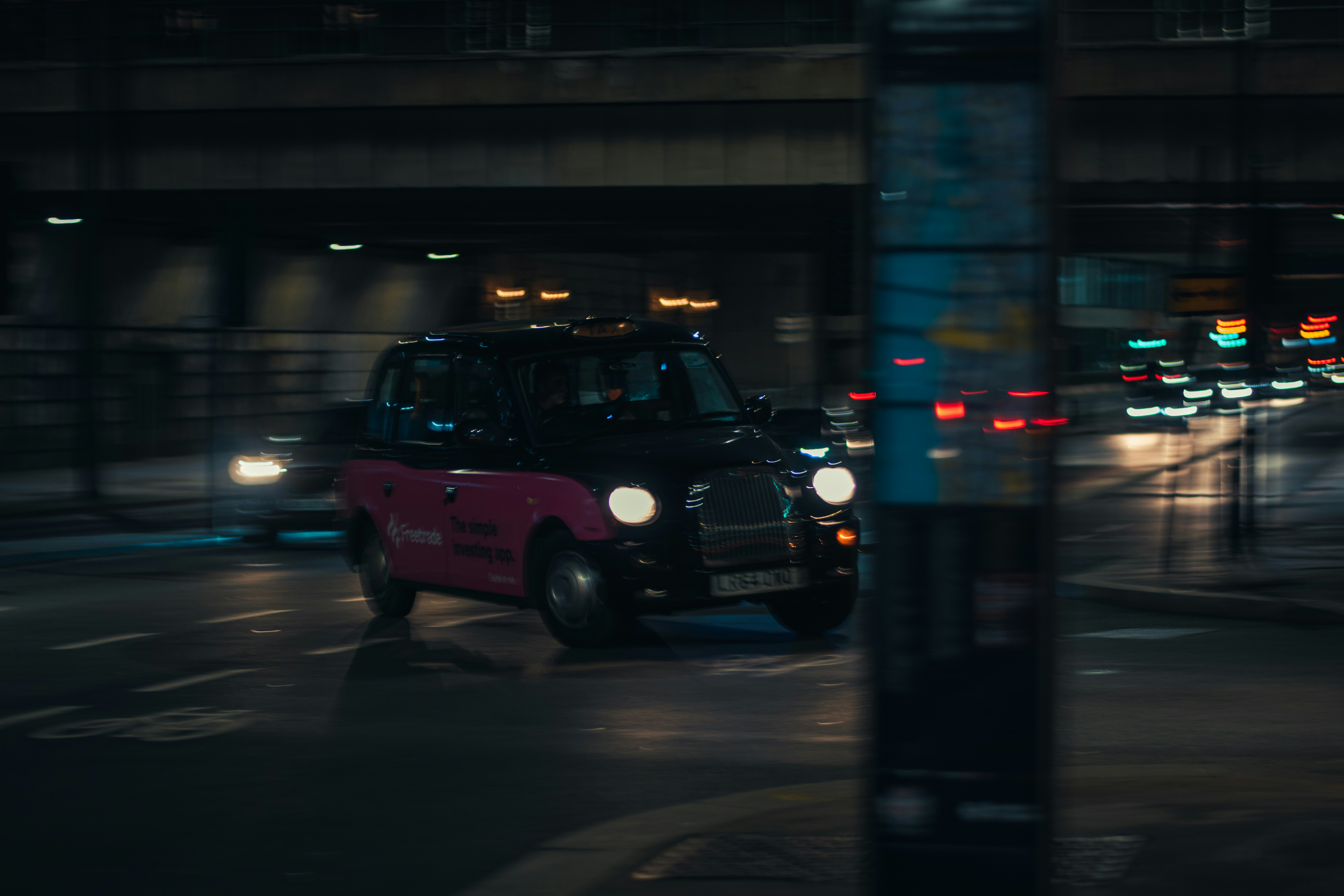 Midnight Pink Taxi Racing Through a Neon Blur