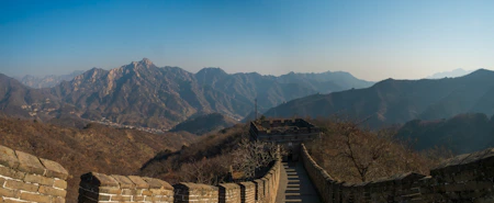 the great wall of china with mountains in the background