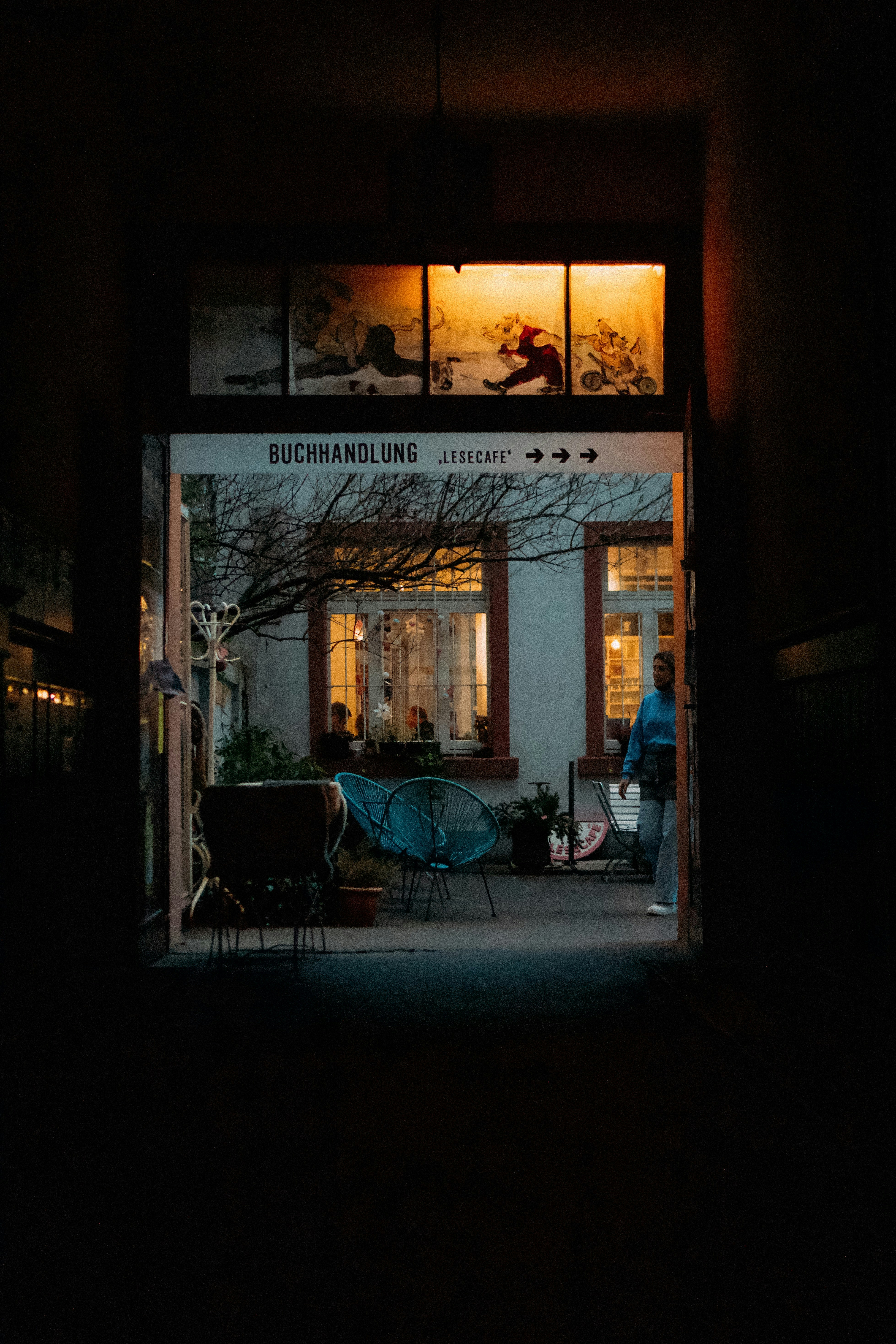 A person standing outside of a building at night photo – Free Germany ...