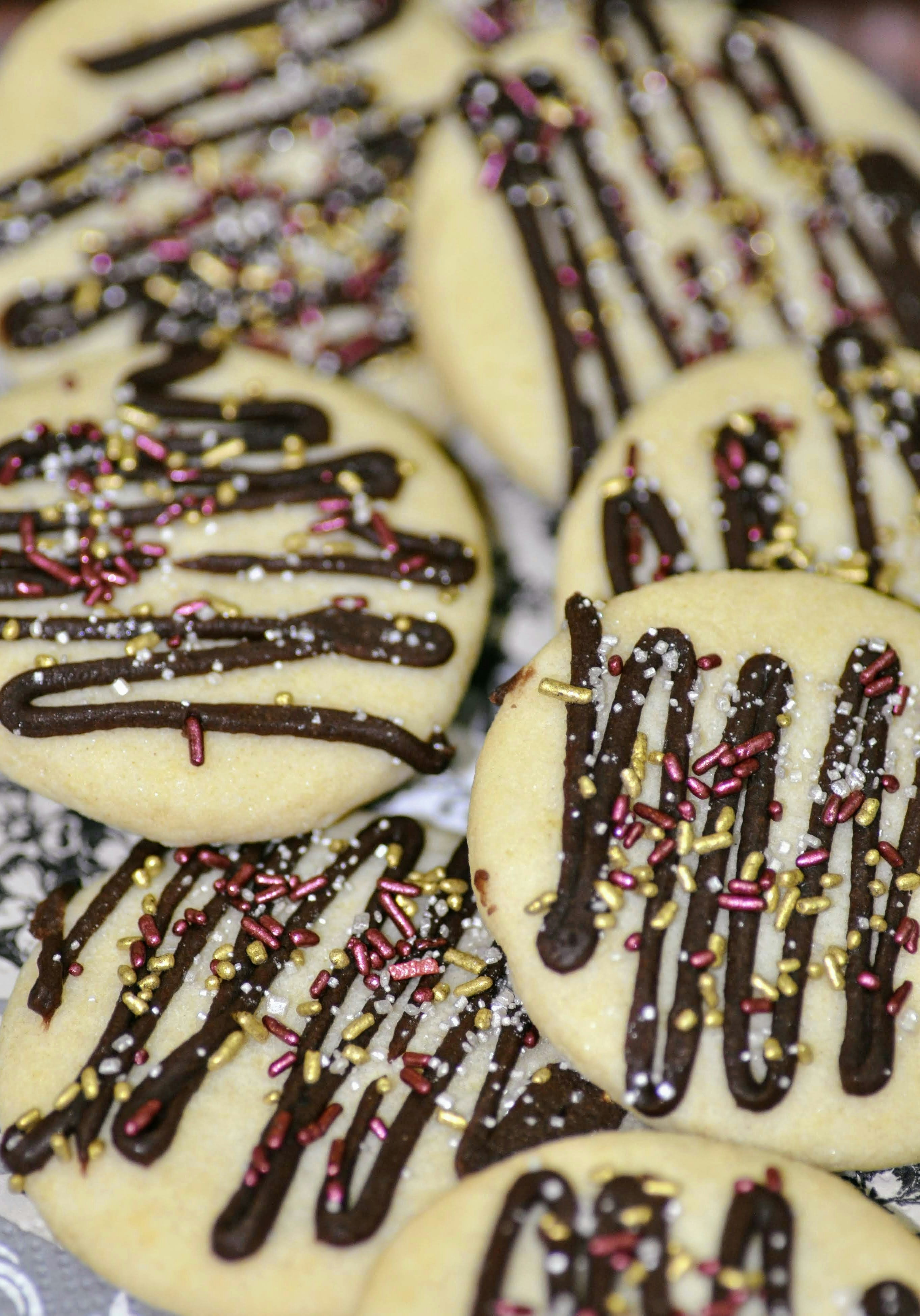 Captured these home made sugar cookies with colored sprinkles drizzled with melted chocolate. 